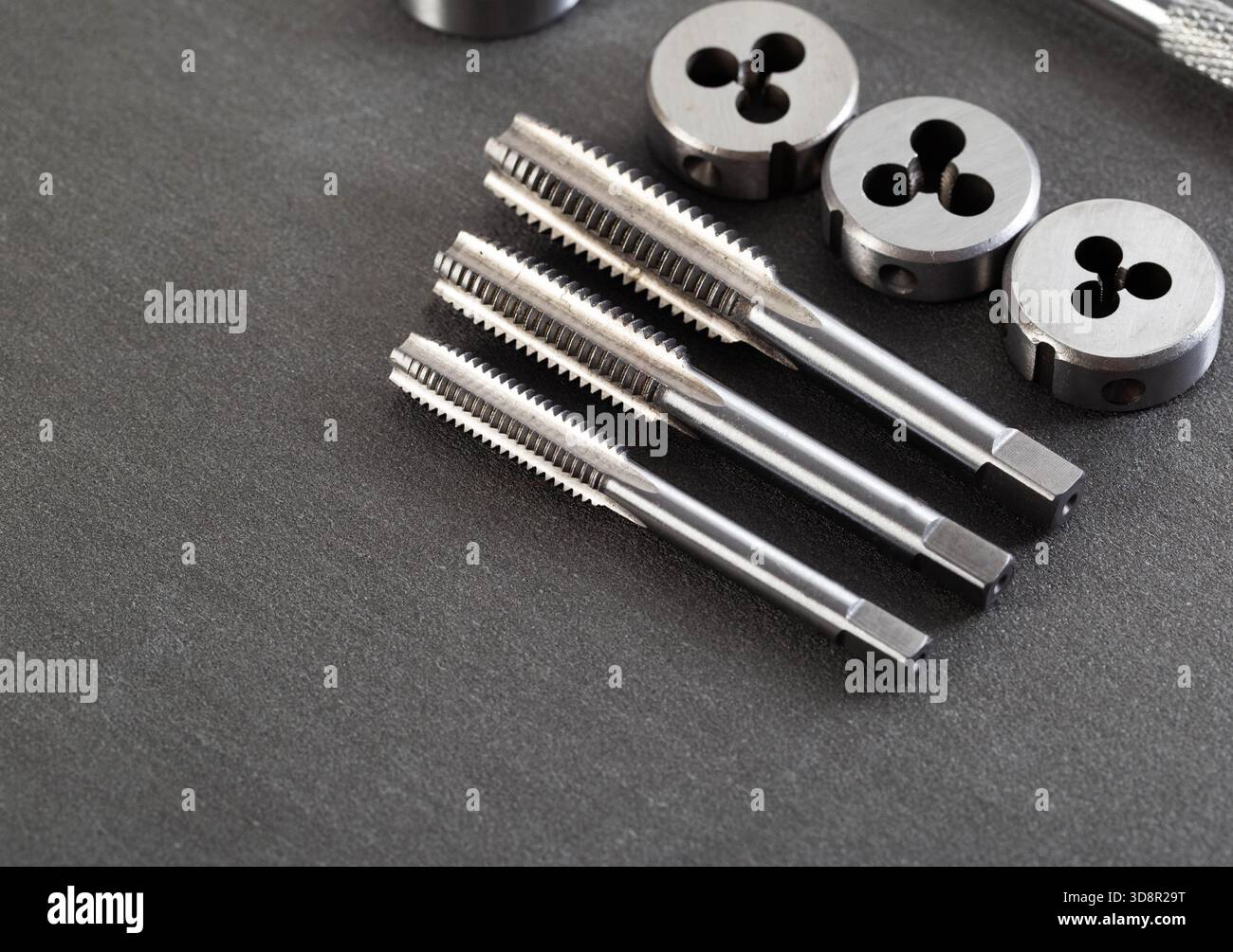 Set of steel threading tools including various sized taps and dies ...