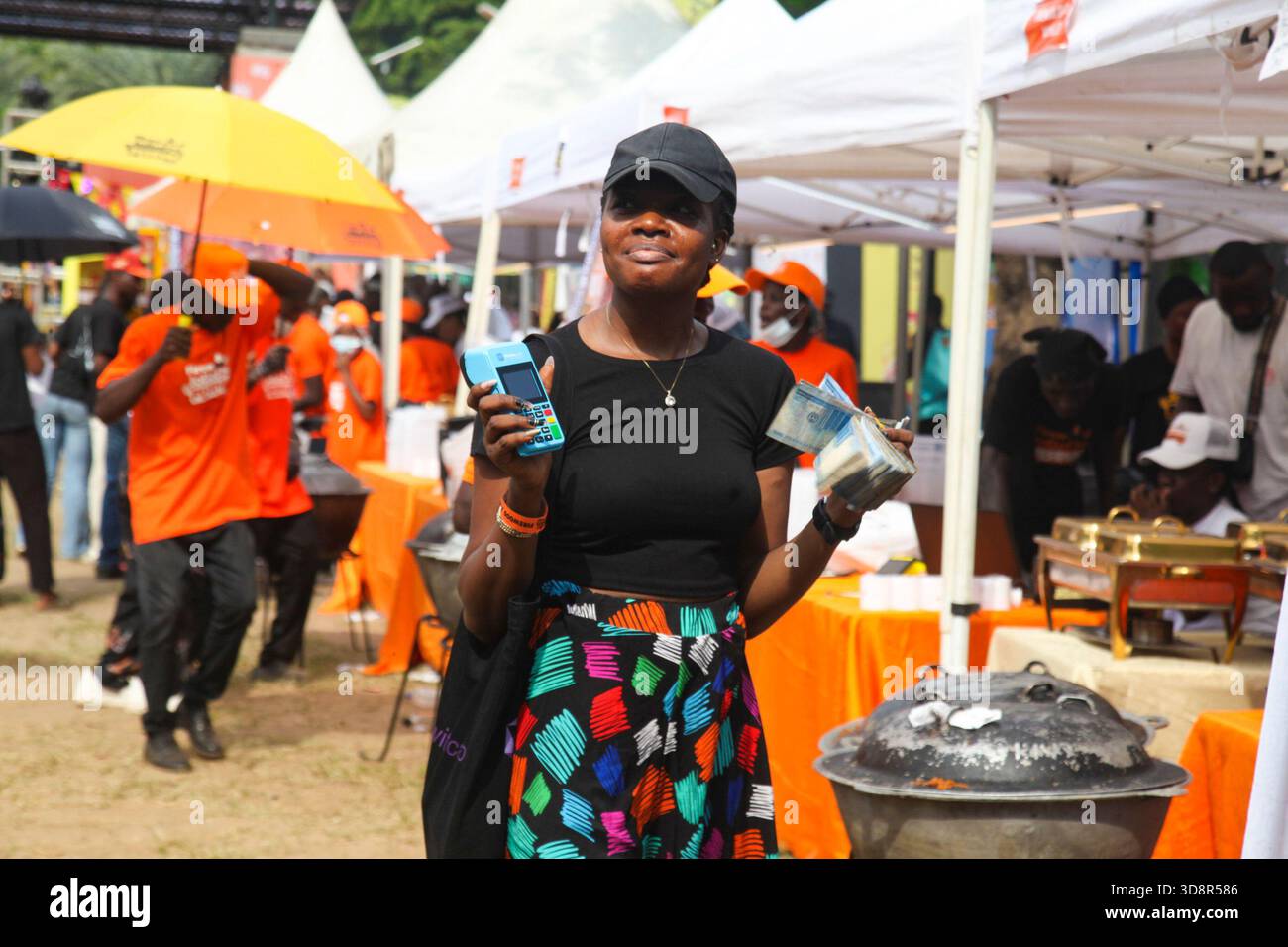 A POS vendor walks around during the Firewood Jollof Festival 2.0 at ...