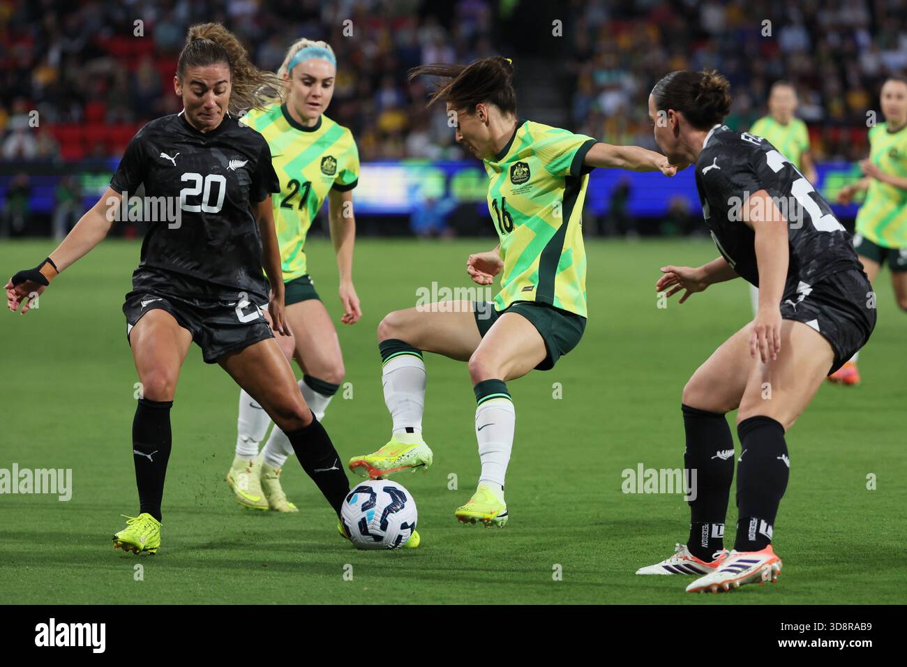 Australia's Hayley Raso, center, looks to go past New Zealand's Indiah-Paige Riley, left, and ...