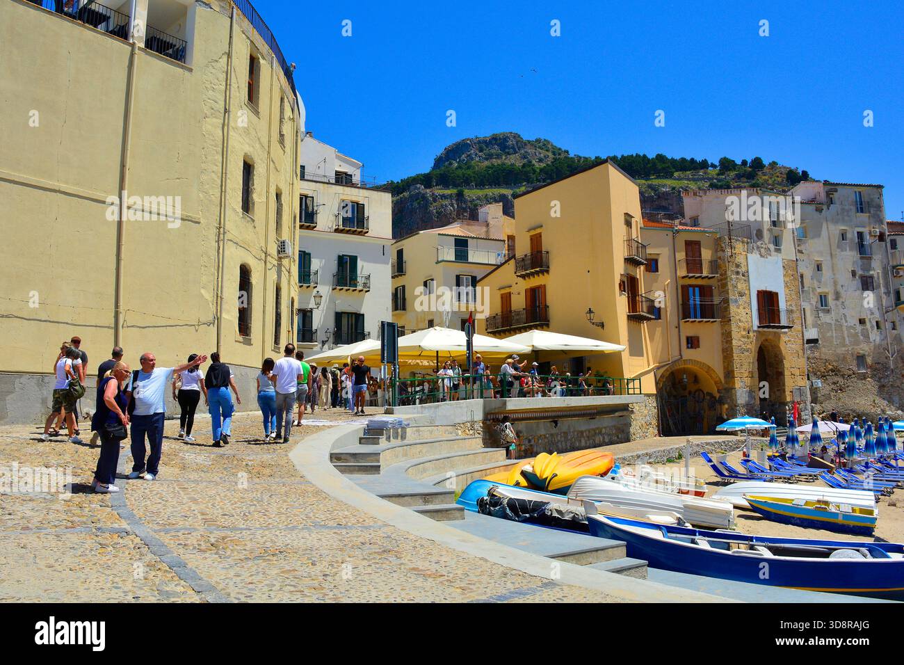 Cefalu, Italy - May 19 2025. The pier on Cefalu waterfront on a late ...