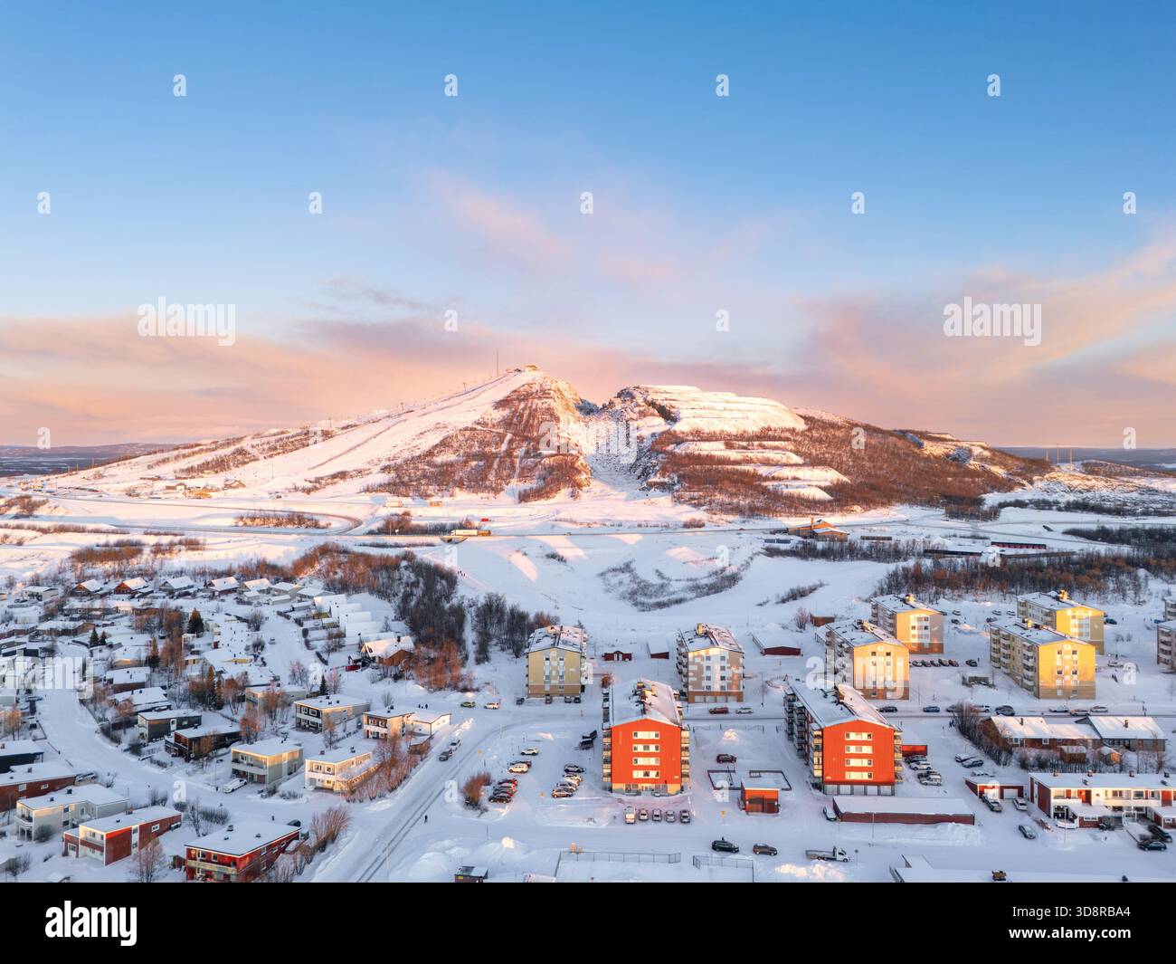 Aerial view of snow-dusted rooftops and colorful buildings nestled ...