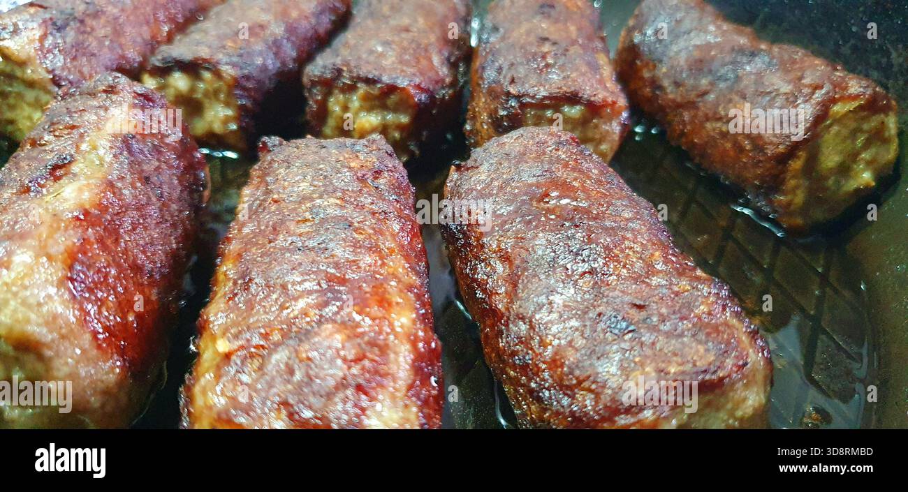 Grilled meat rolls - mici,a romanian traditional food on a pan,minced ...