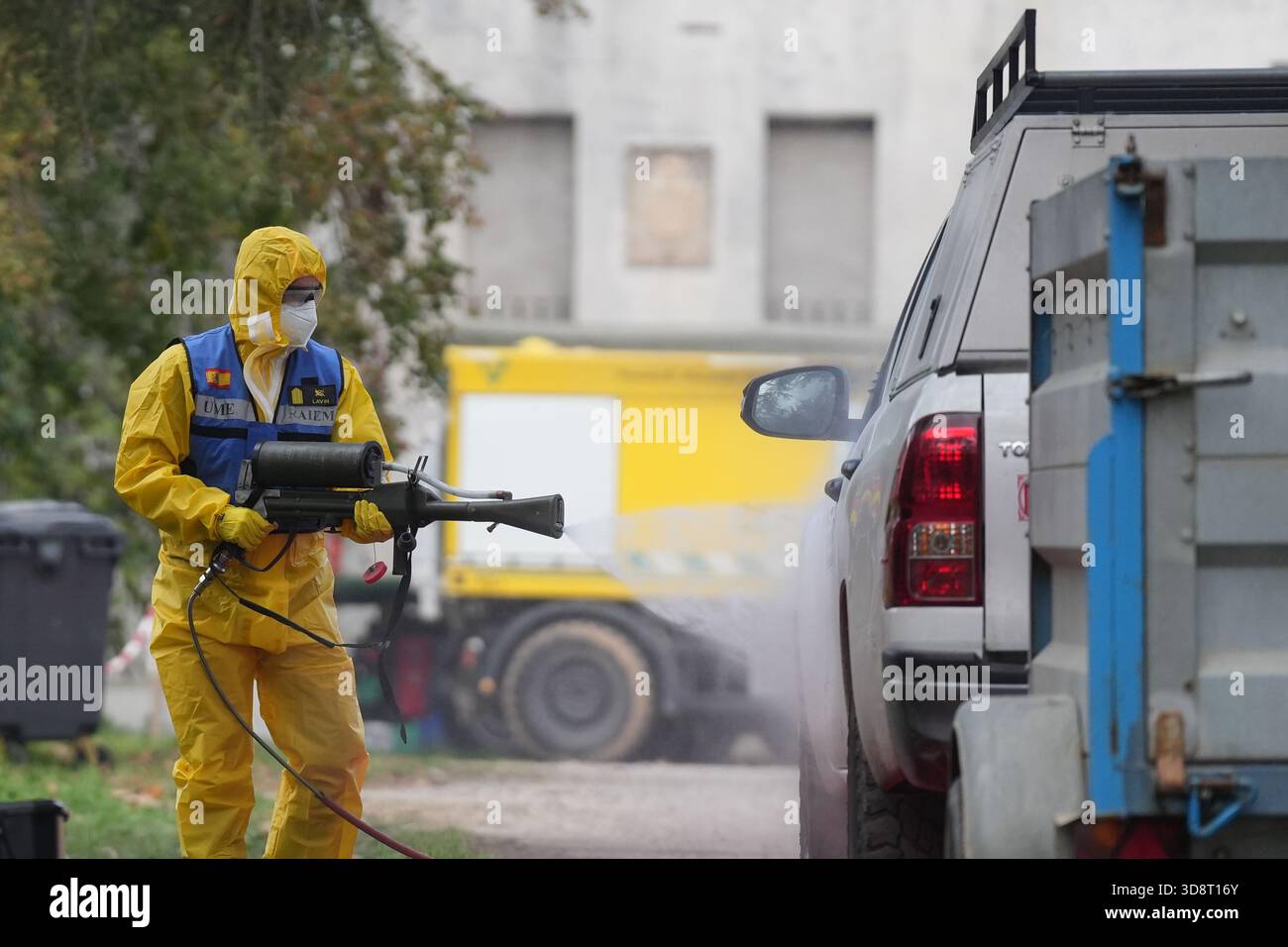 A member of the EMU disinfects vehicles during the presentation of the ...
