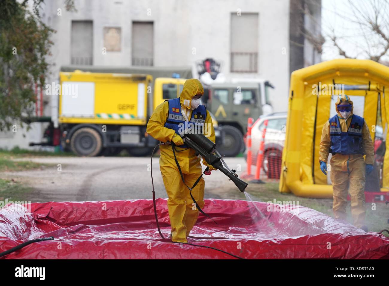 A member of the EMU disinfects vehicles during the presentation of the ...