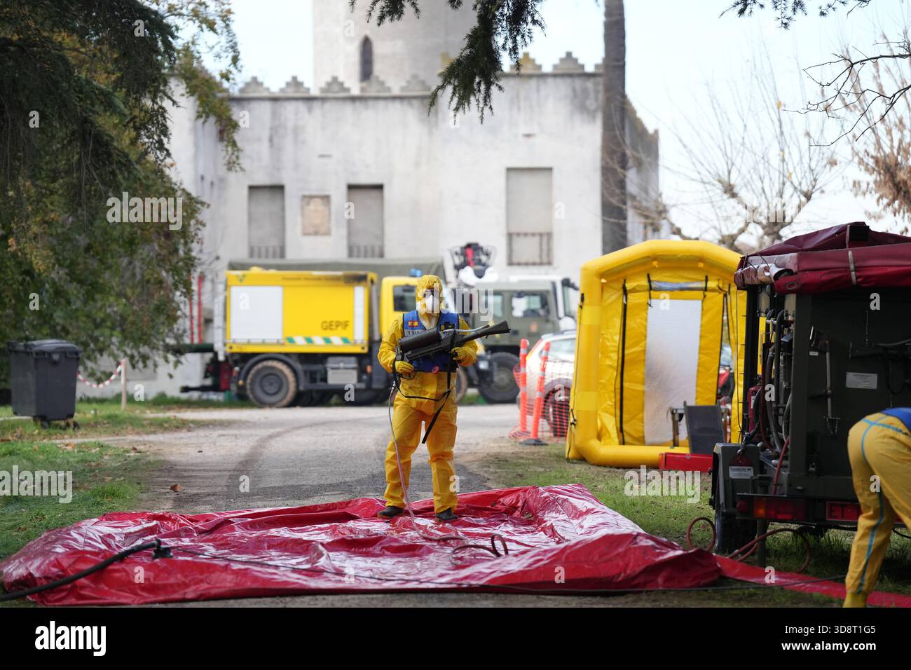 A member of the EMU disinfects vehicles during the presentation of the ...