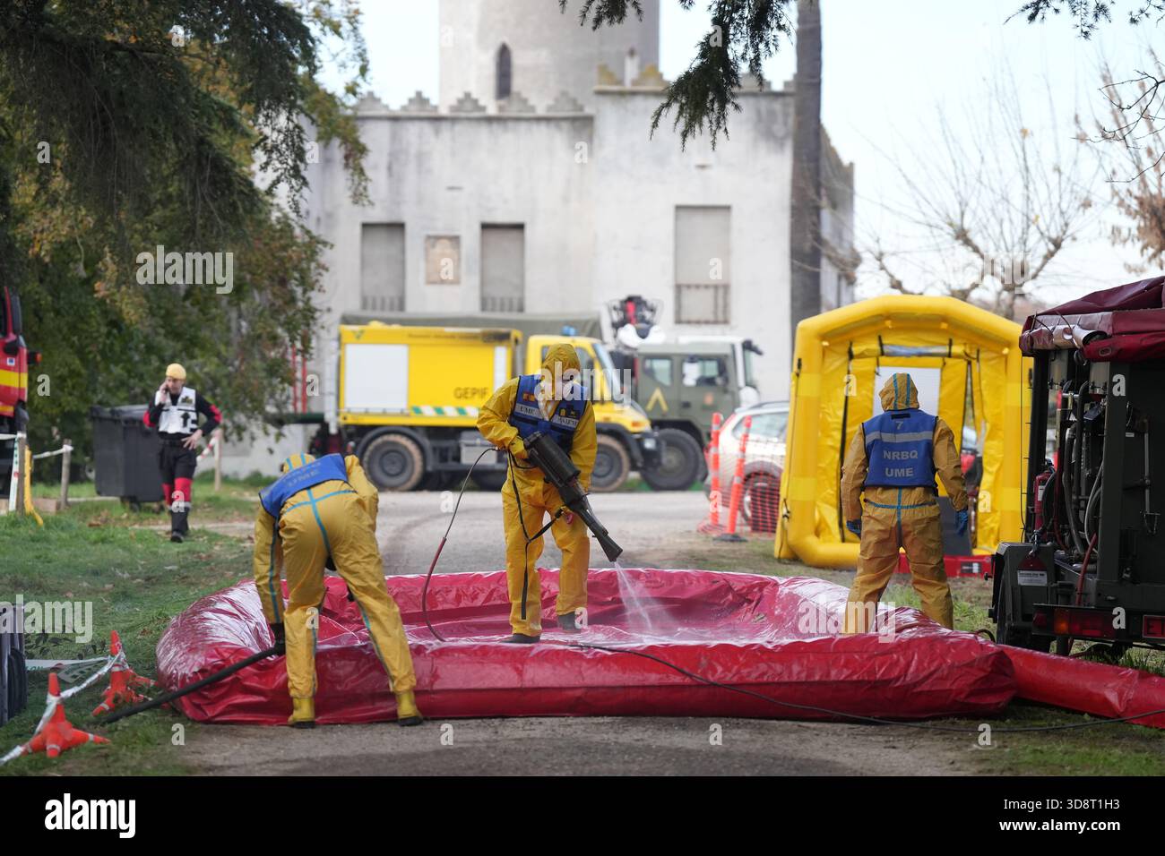 Several EMU personnel disinfect vehicles during the presentation of EMU ...
