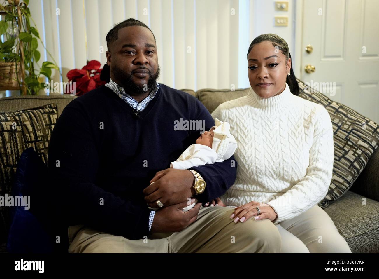 Leon and Mercedes Wells hold their newborn daughter Alena at their home ...