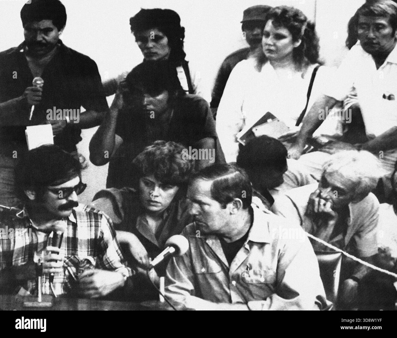 FILE - Eugene Hasenfus (bottom, center) listens as Jose Peres ...