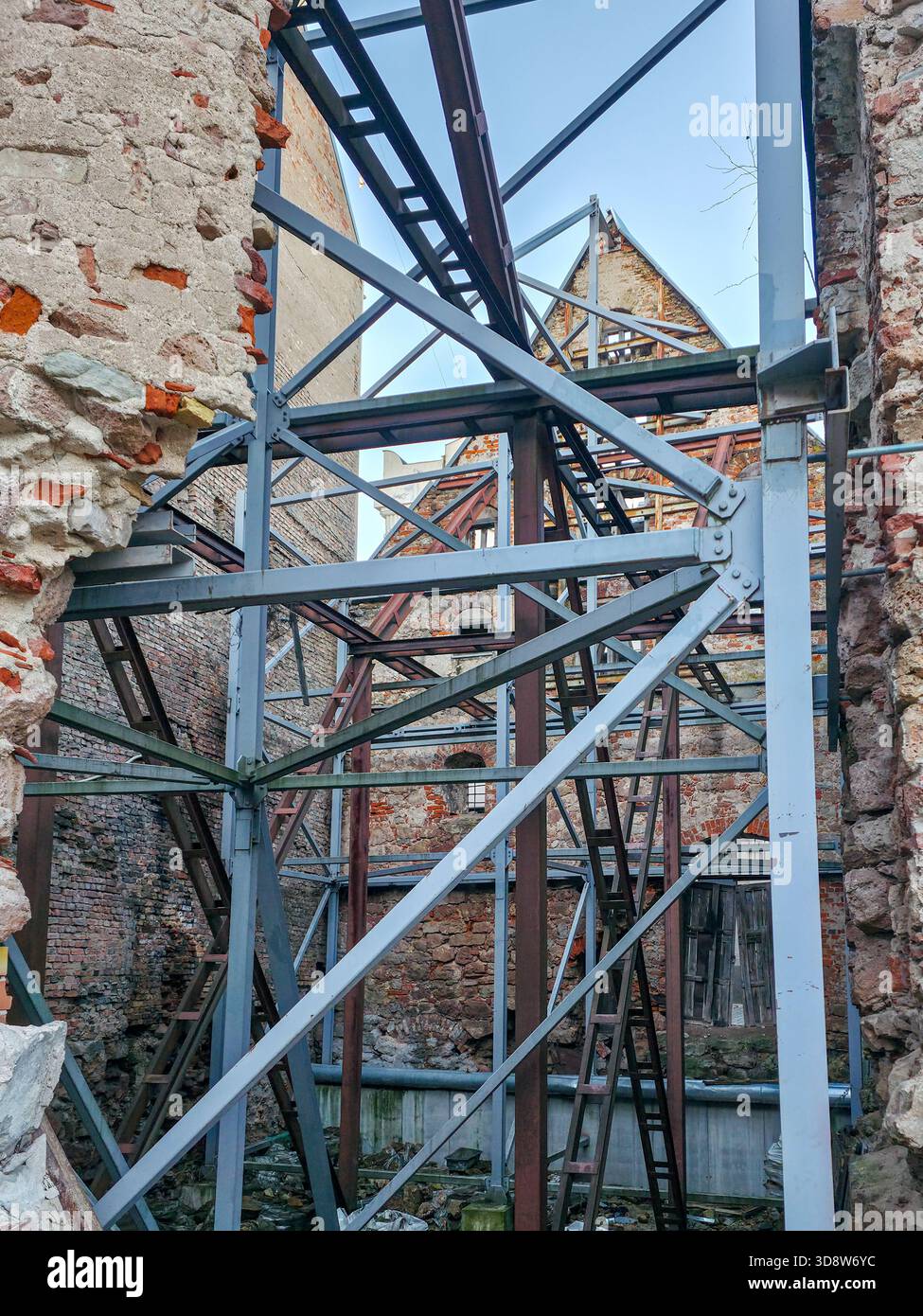 Historic brick building ruins with metal support frames in Old Riga ...