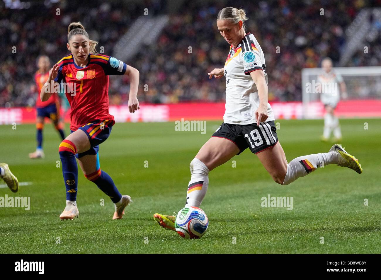 Germany's Klara Buehl, right, kicks the ball ahead of Spain's Vicky ...