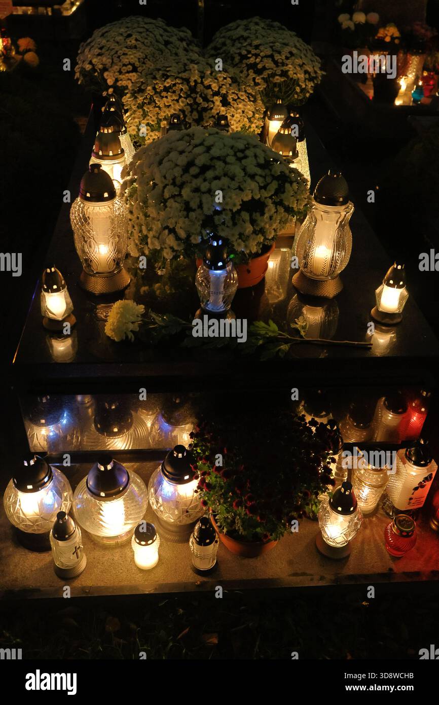 Solemn Remembrance Grave Lanterns and Flowers at Night Stock Photo - Alamy