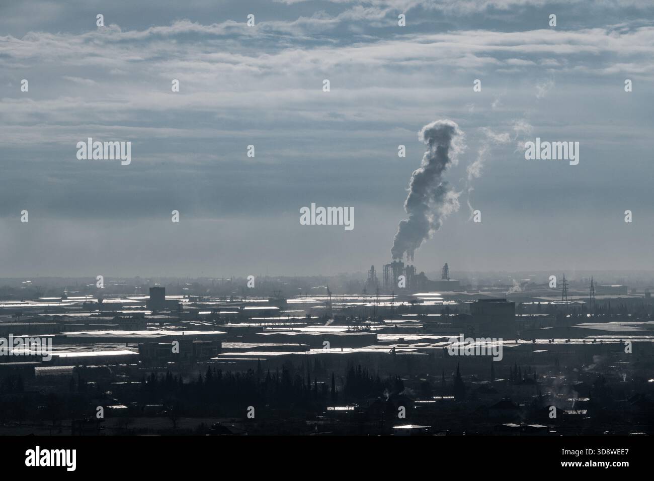 A city photo depicting industrial air pollution. Factory smoke in ...