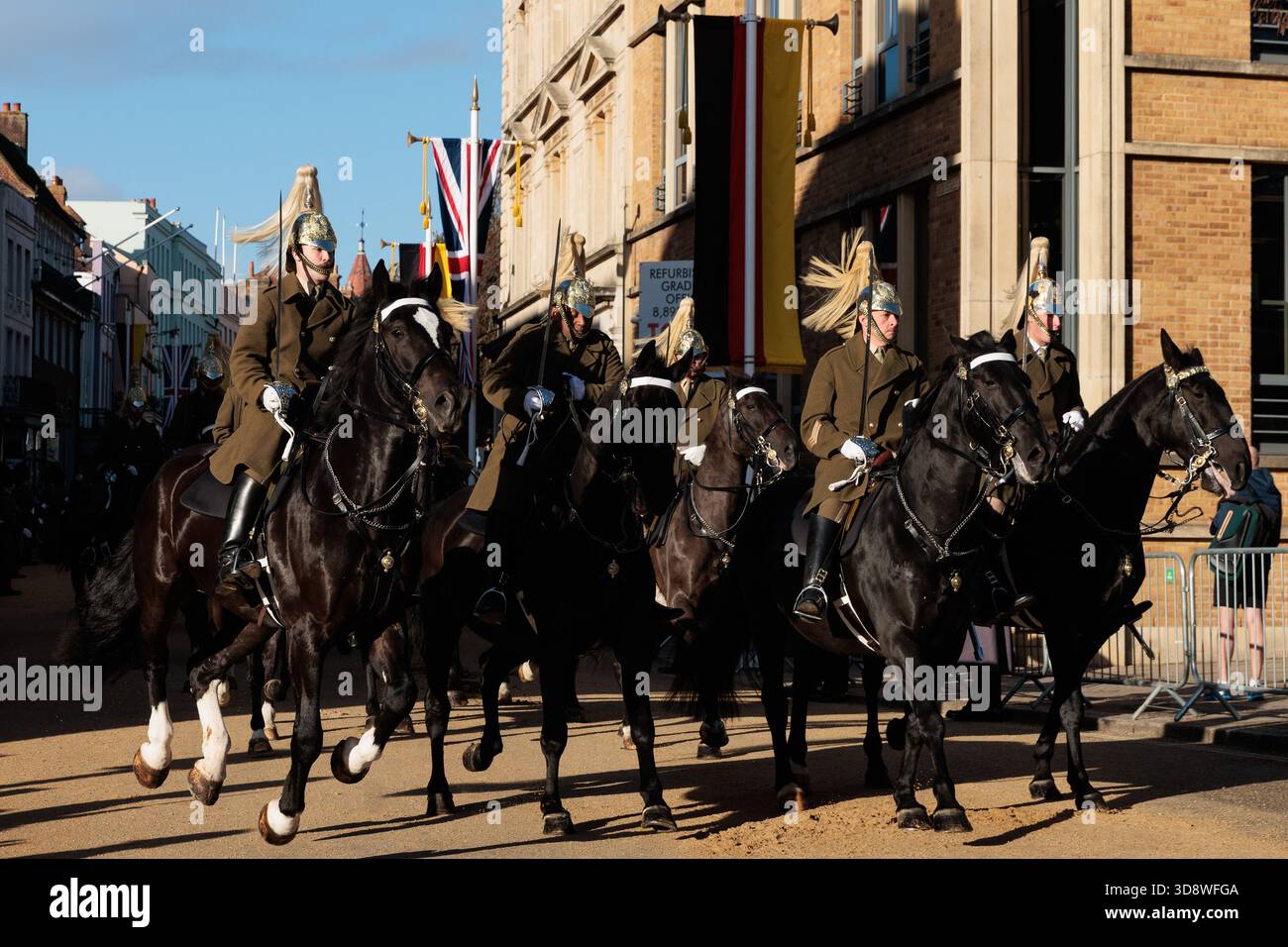 Windsor, UK. 2nd December, 2025. Mounted guardsmen pass along the High ...
