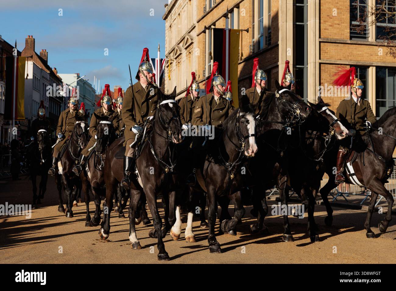 Windsor, UK. 2nd December, 2025. Mounted guardsmen pass along the High ...