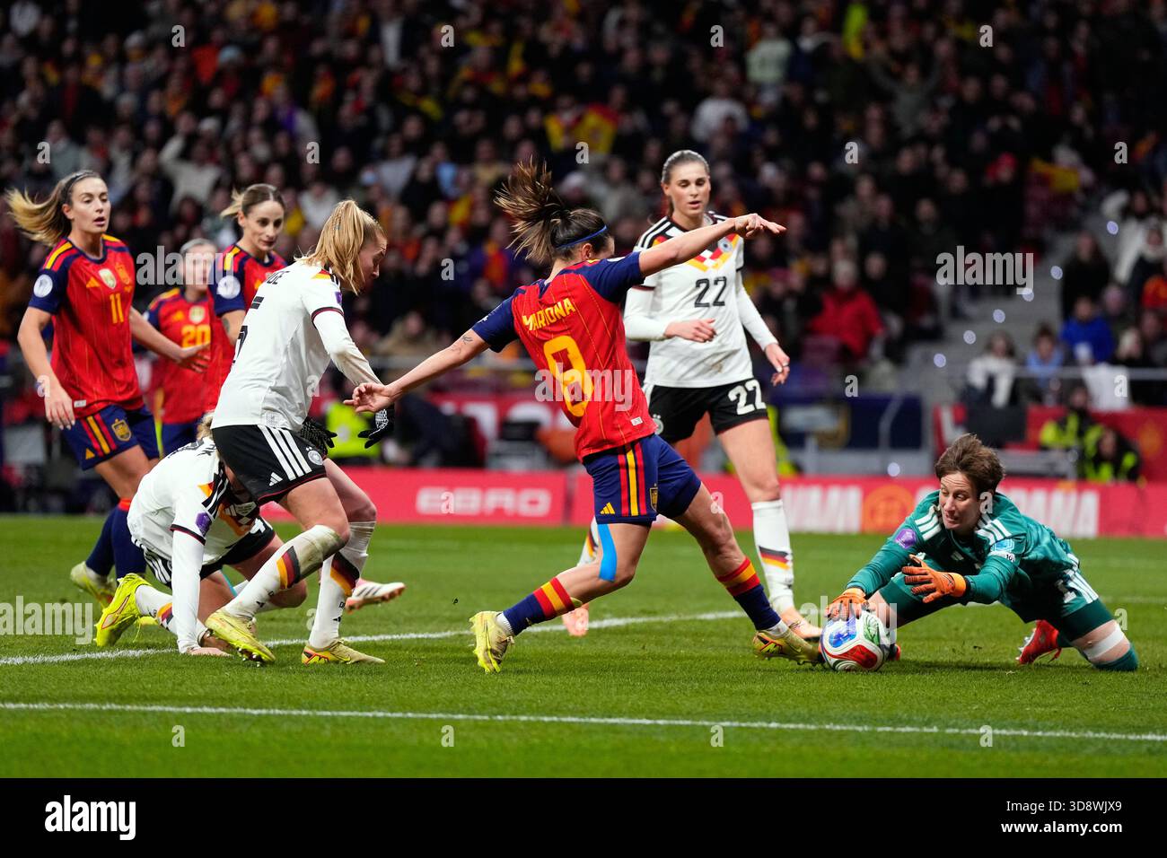 Germany goalkeeper Ann-Katrin Berger dives for a save in front of Spain ...
