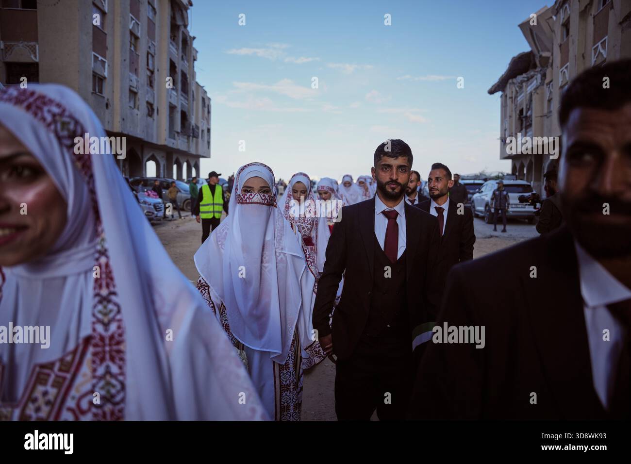 Palestinian couples participate in a mass wedding ceremony at Hamad ...
