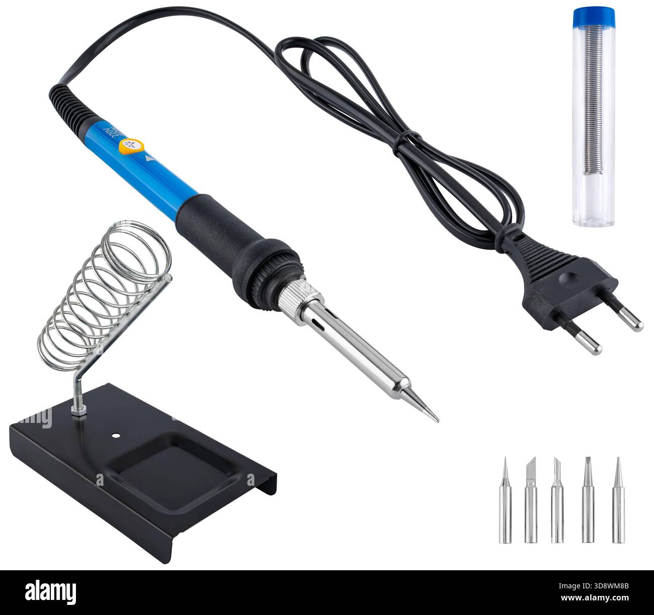 Compact soldering iron with stand, set of tips, and solder, on a white ...