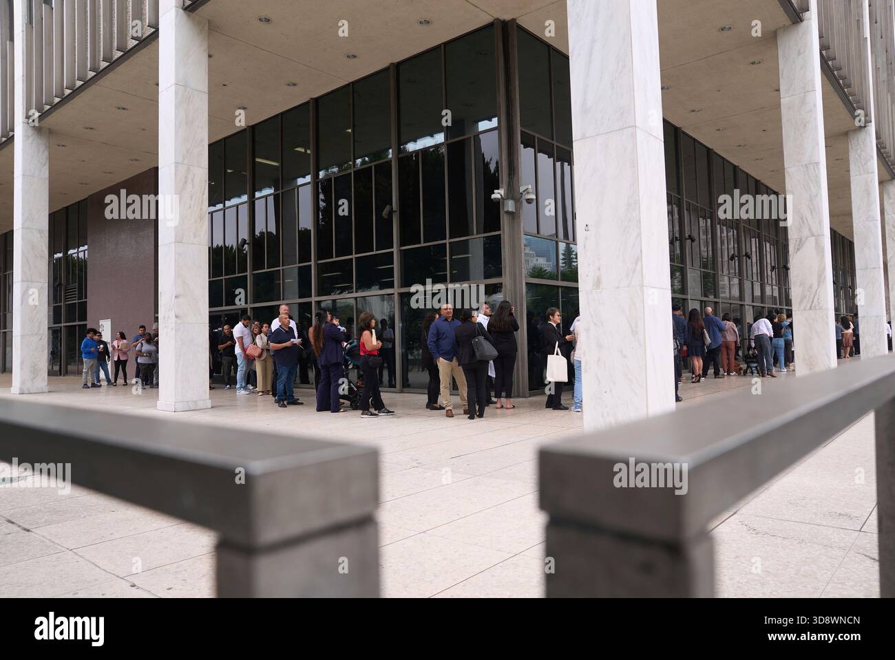 FILE - People line up outside the Los Angeles Federal Building in Los ...