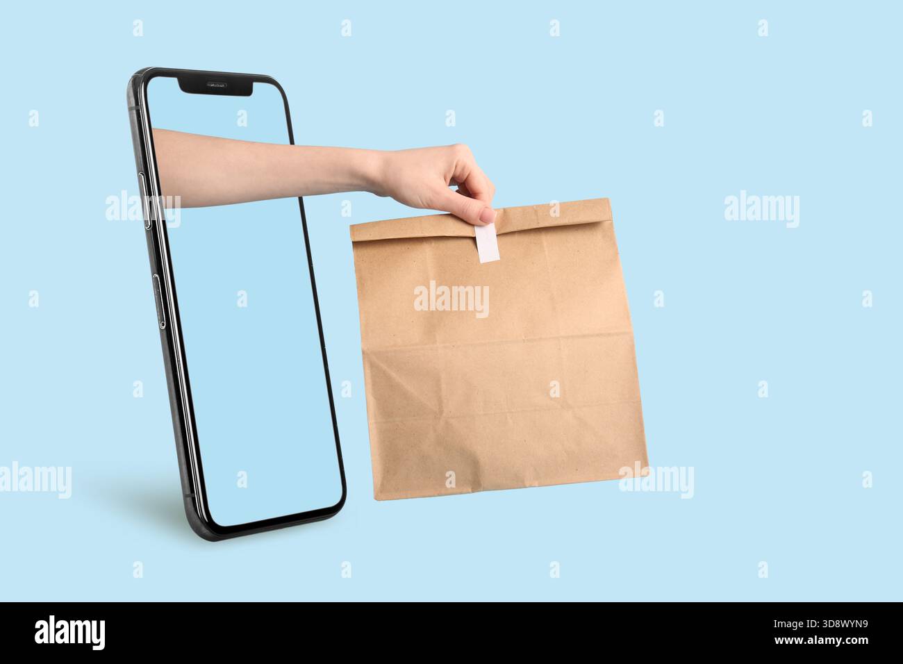 Hand with paper bag popping out of smartphone screen on blue background ...