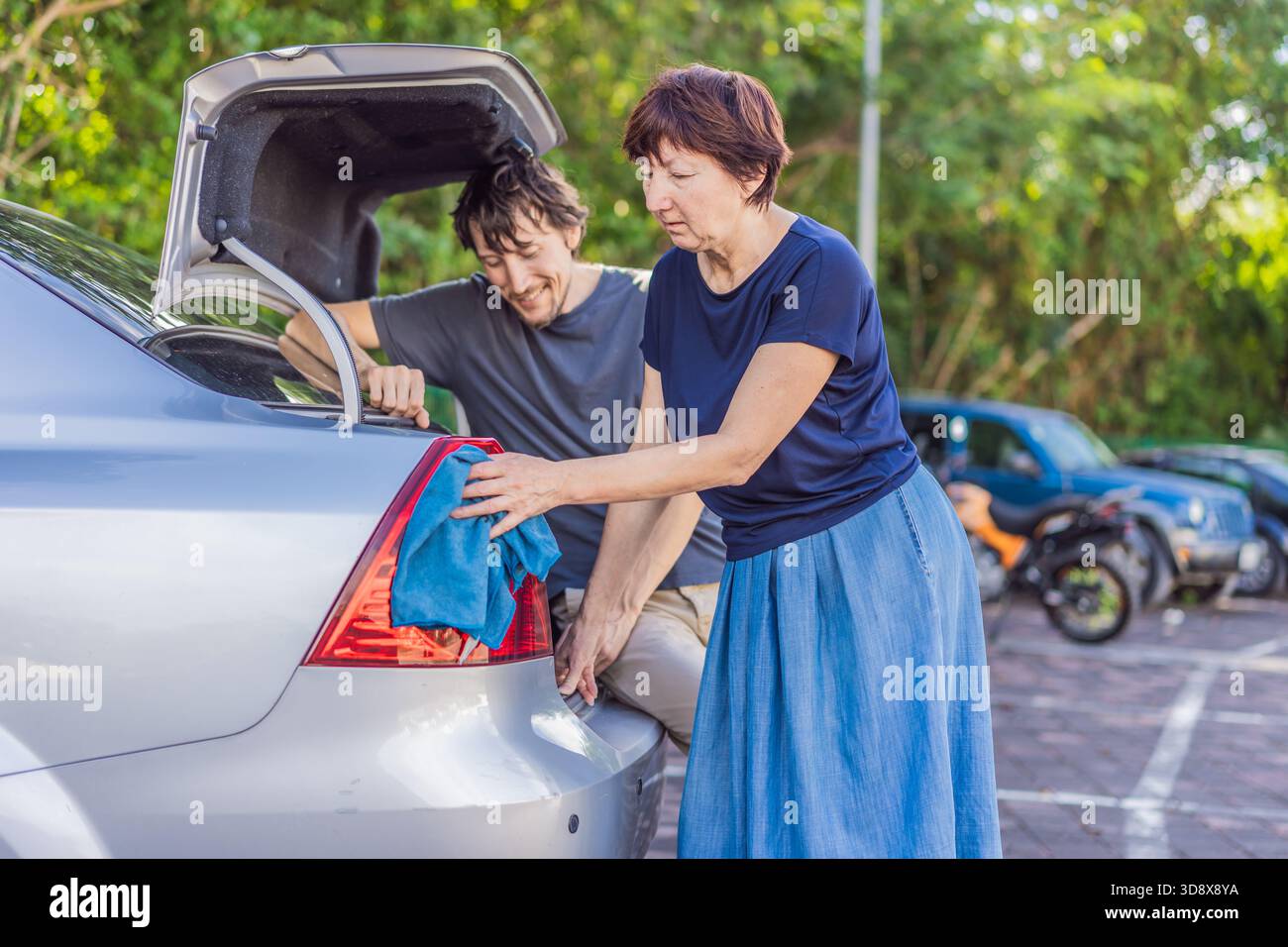Older woman washing car hi-res stock photography and images - Alamy