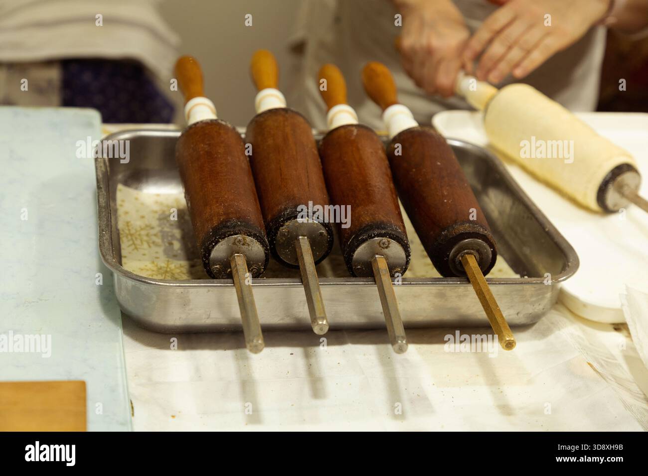 potbelly pig. Wooden rolling pins are neatly arranged in a tray on a ...
