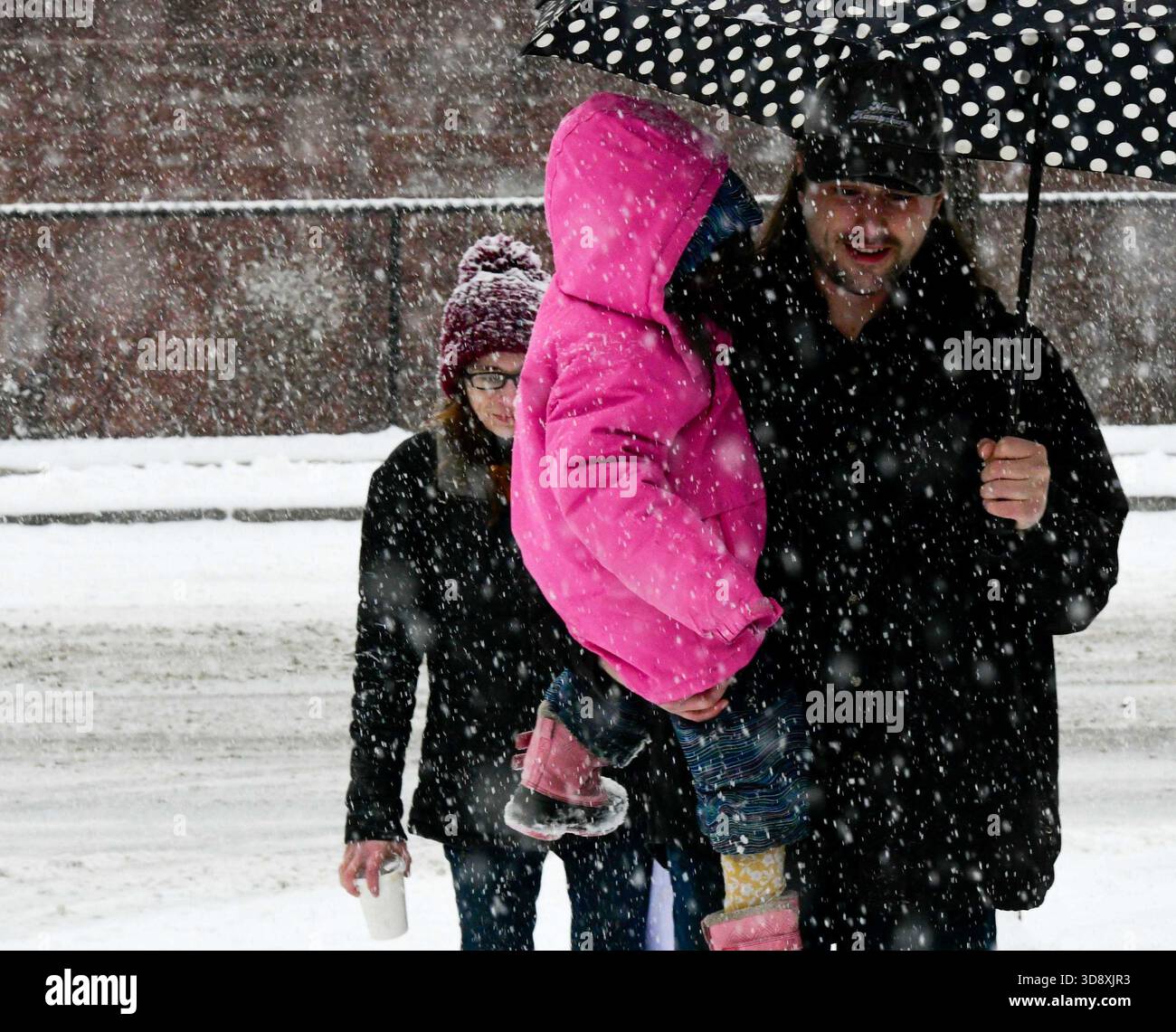 Bobby Raymond of Brattleboro, Vt., carries his 5-year-old daughter ...