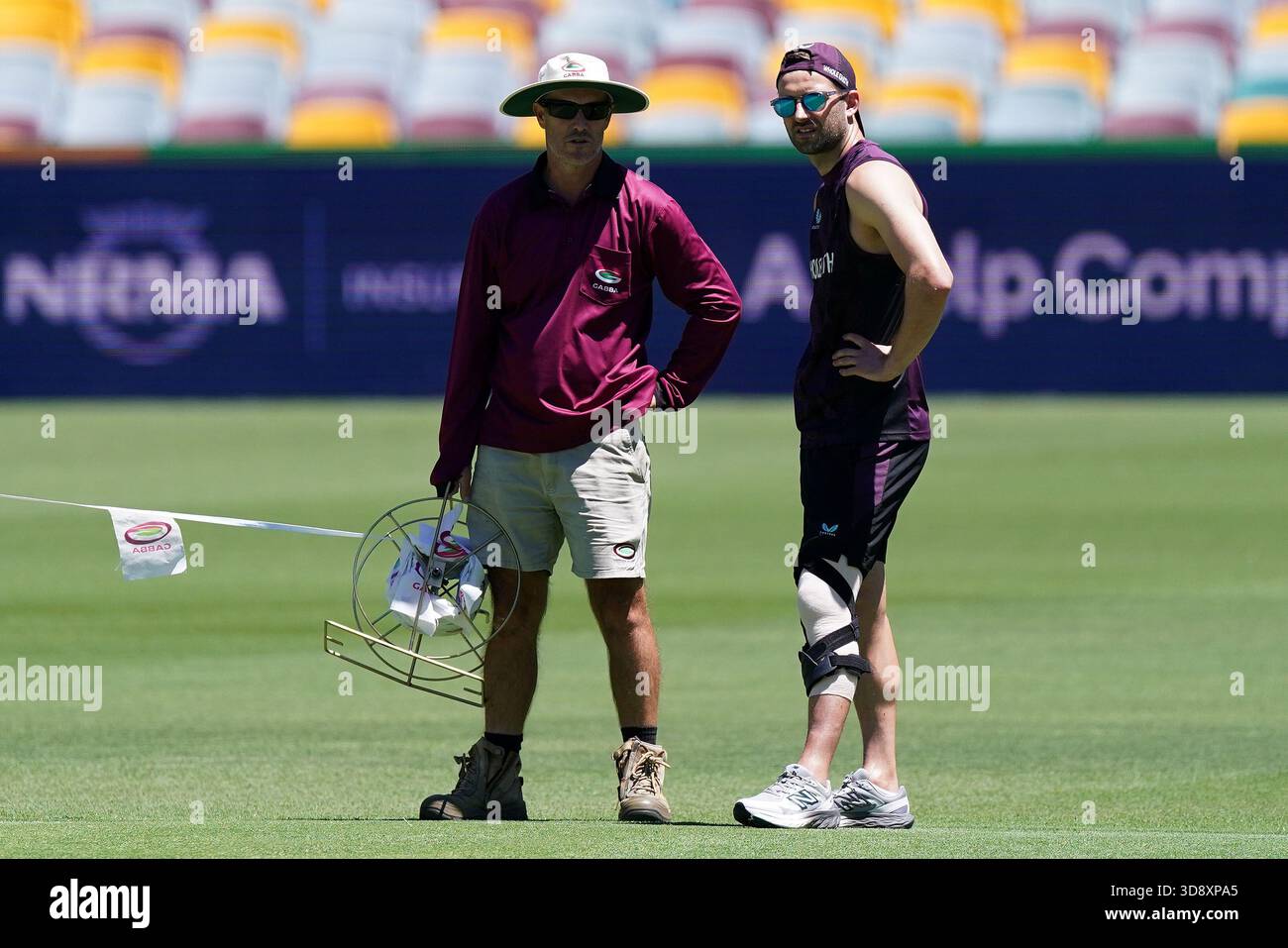 England’s Mark Wood (right) speaks to a member of the ground staff ...