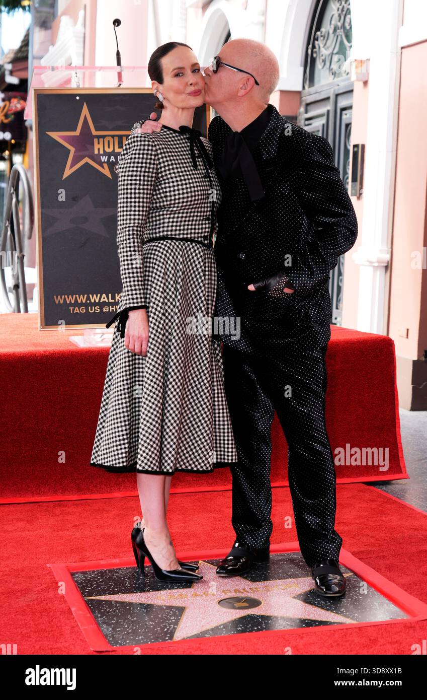 Actor Sarah Paulson, left, gets a kiss from guest speaker Ryan Murphy ...