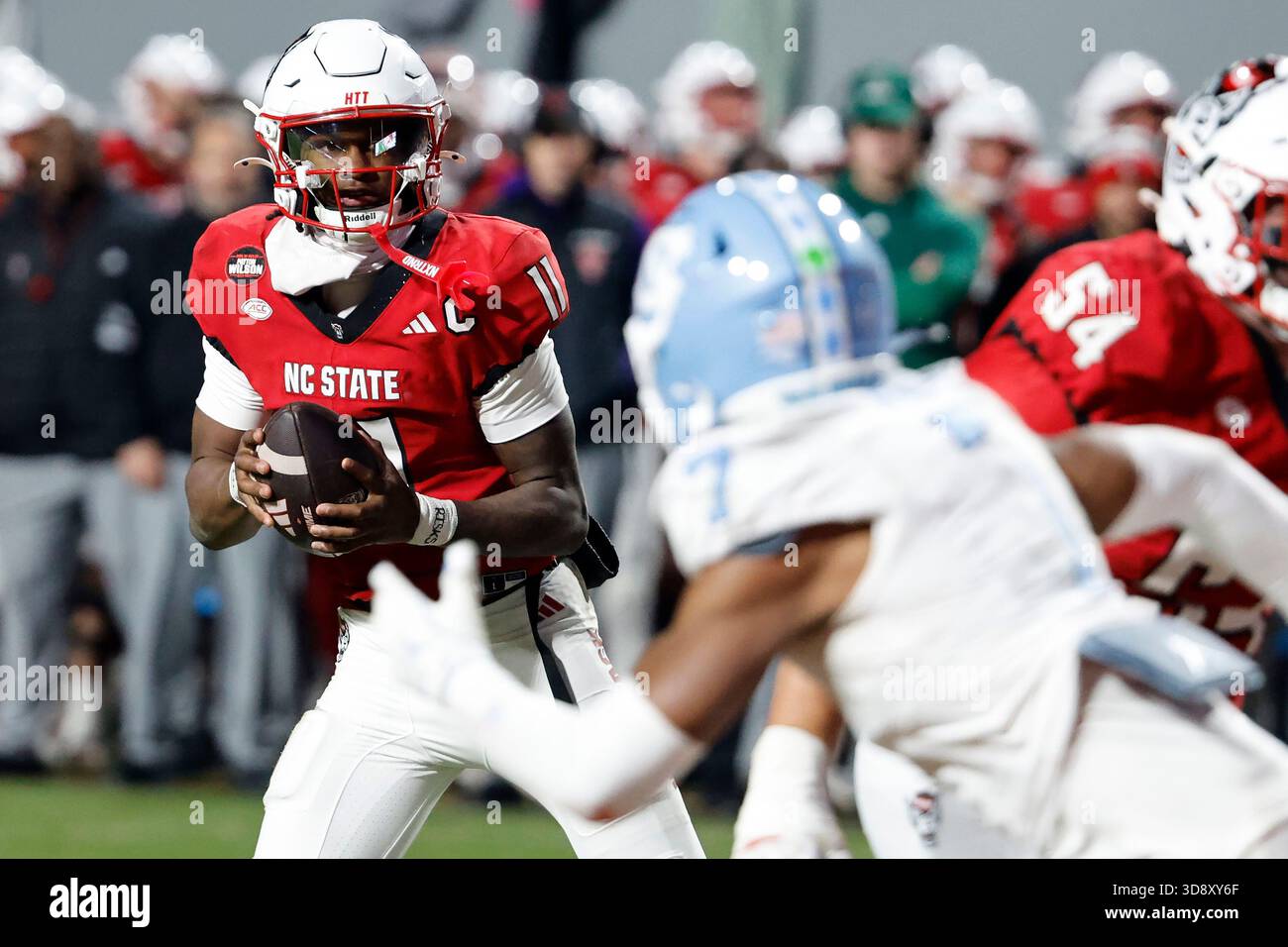 North Carolina State quarterback CJ Bailey (11) looks at the defense of ...