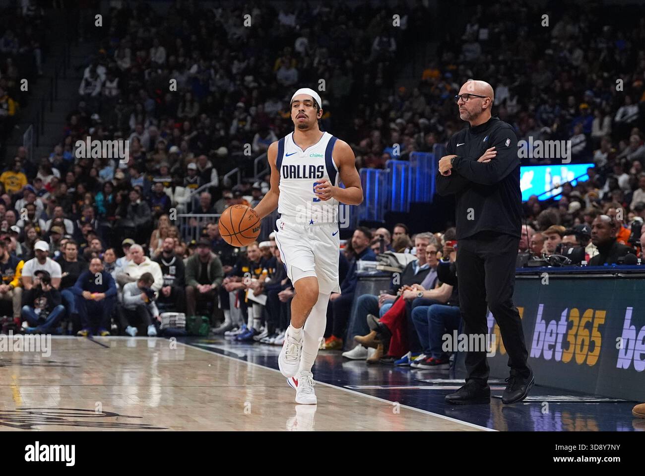 Dallas Mavericks guard Ryan Nembhard (9) passes by head coach Jason ...