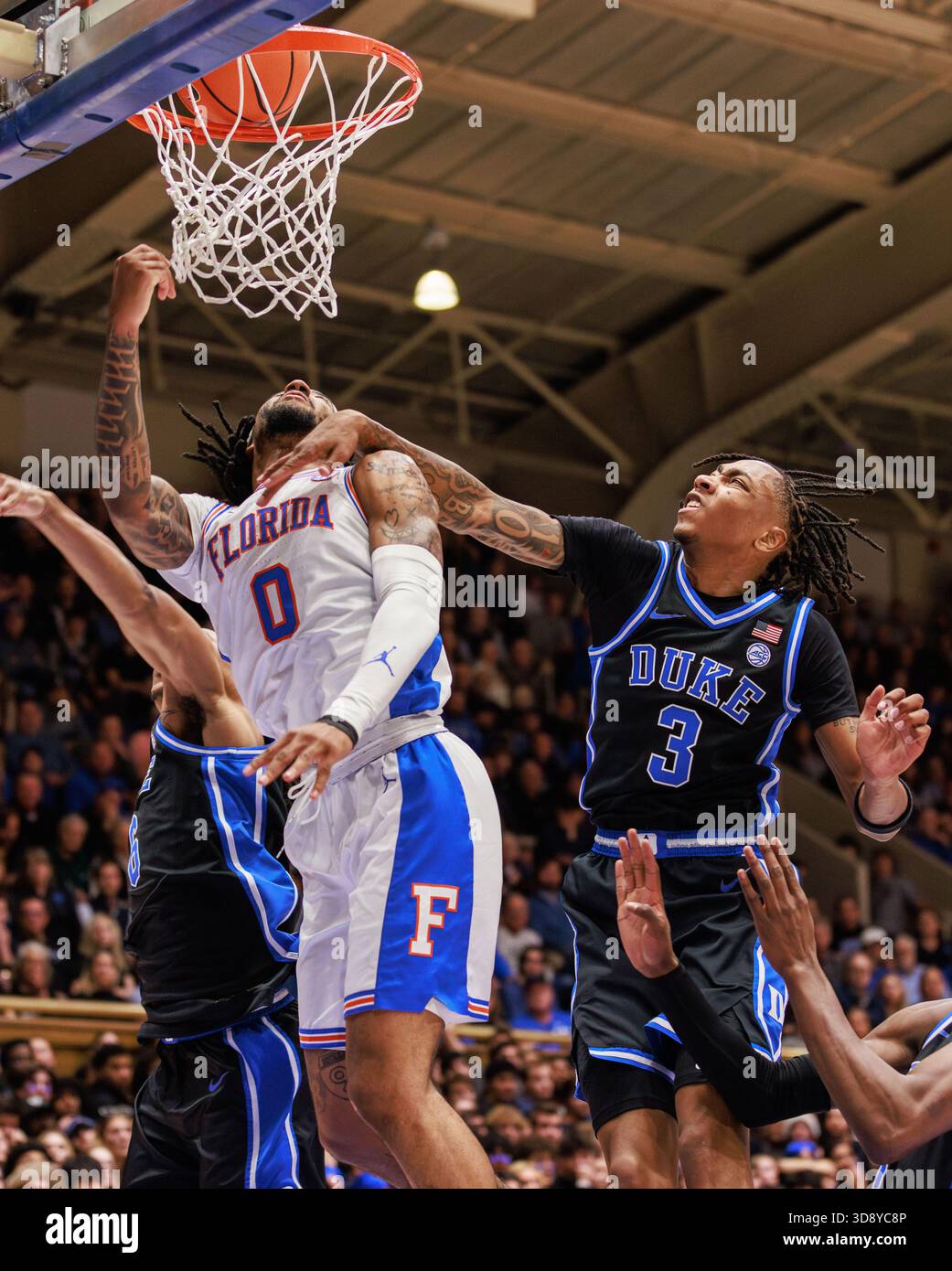 Florida's Boogie Fland (0) attempts a layup ahead of Duke's Isaiah ...