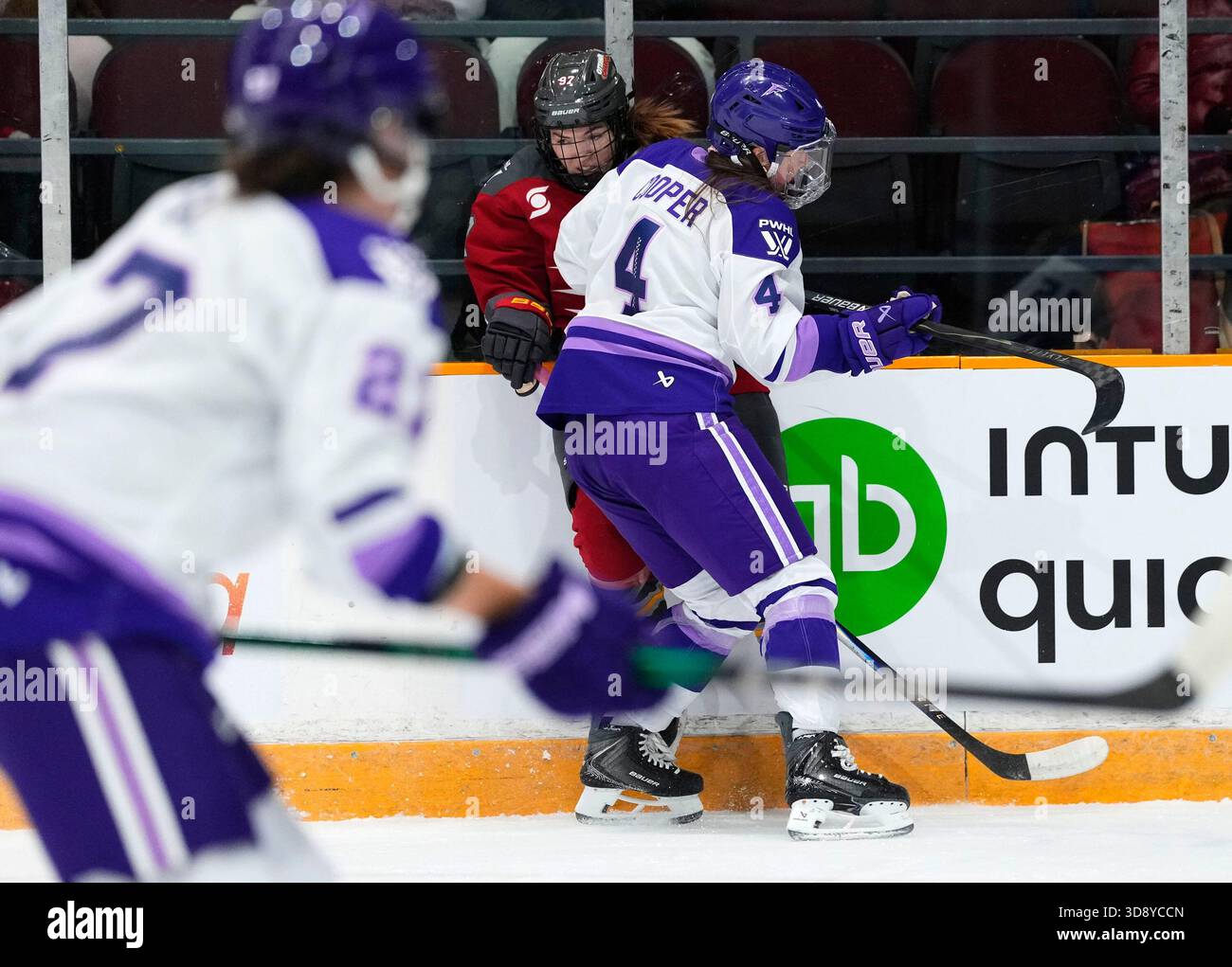 Minnesota Frost's Kendall Cooper (4) clashes along the boards with ...