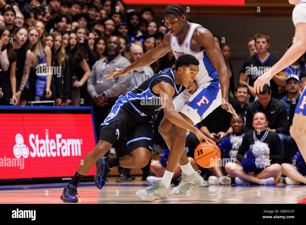 Duke's Caleb Foster (1) handles the ball as Florida's Rueben Chinyelu, right, defends during the ...
