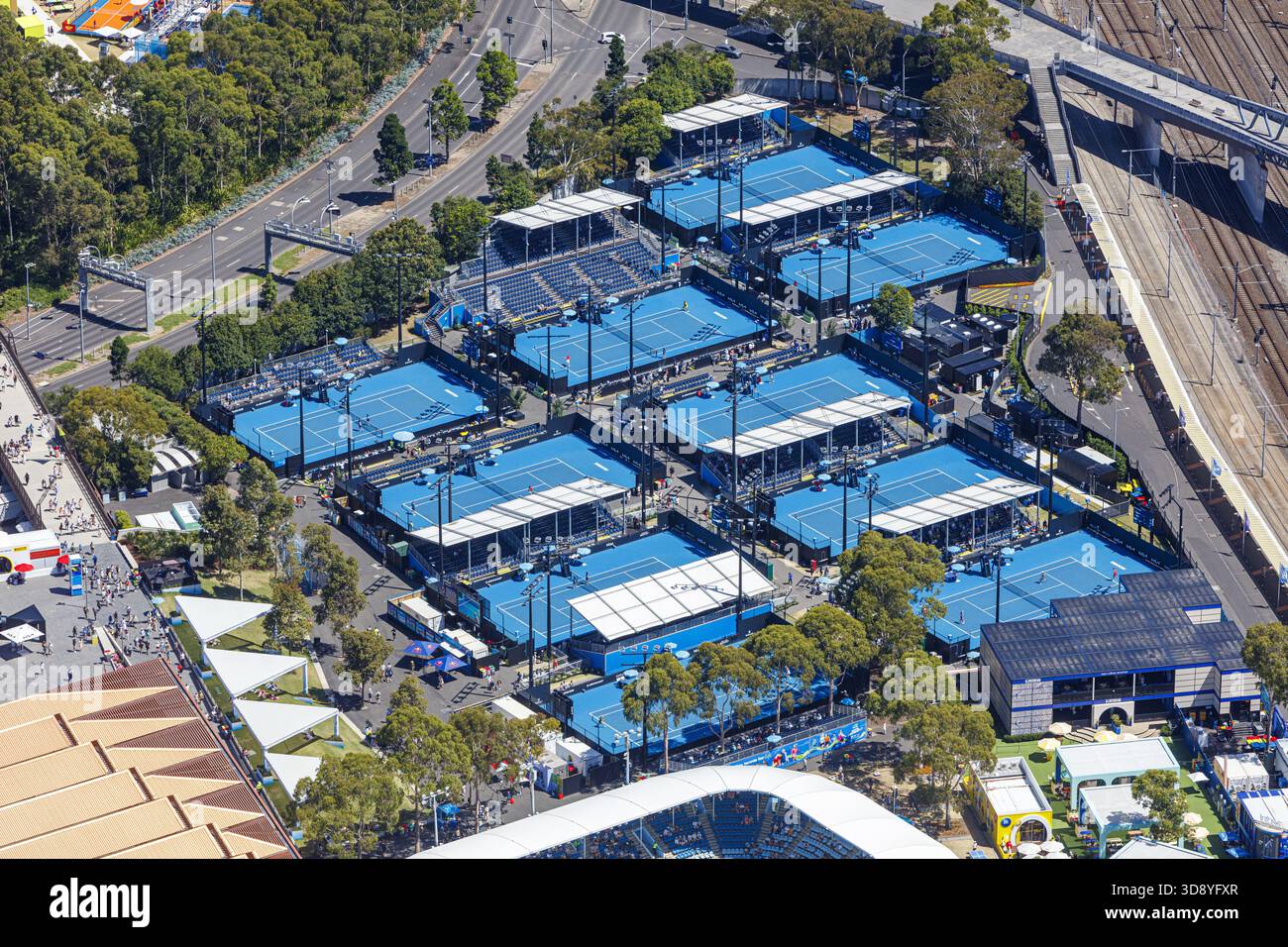 Aerial view of the vibrant blue tennis courts at Melbourne Park, a ...