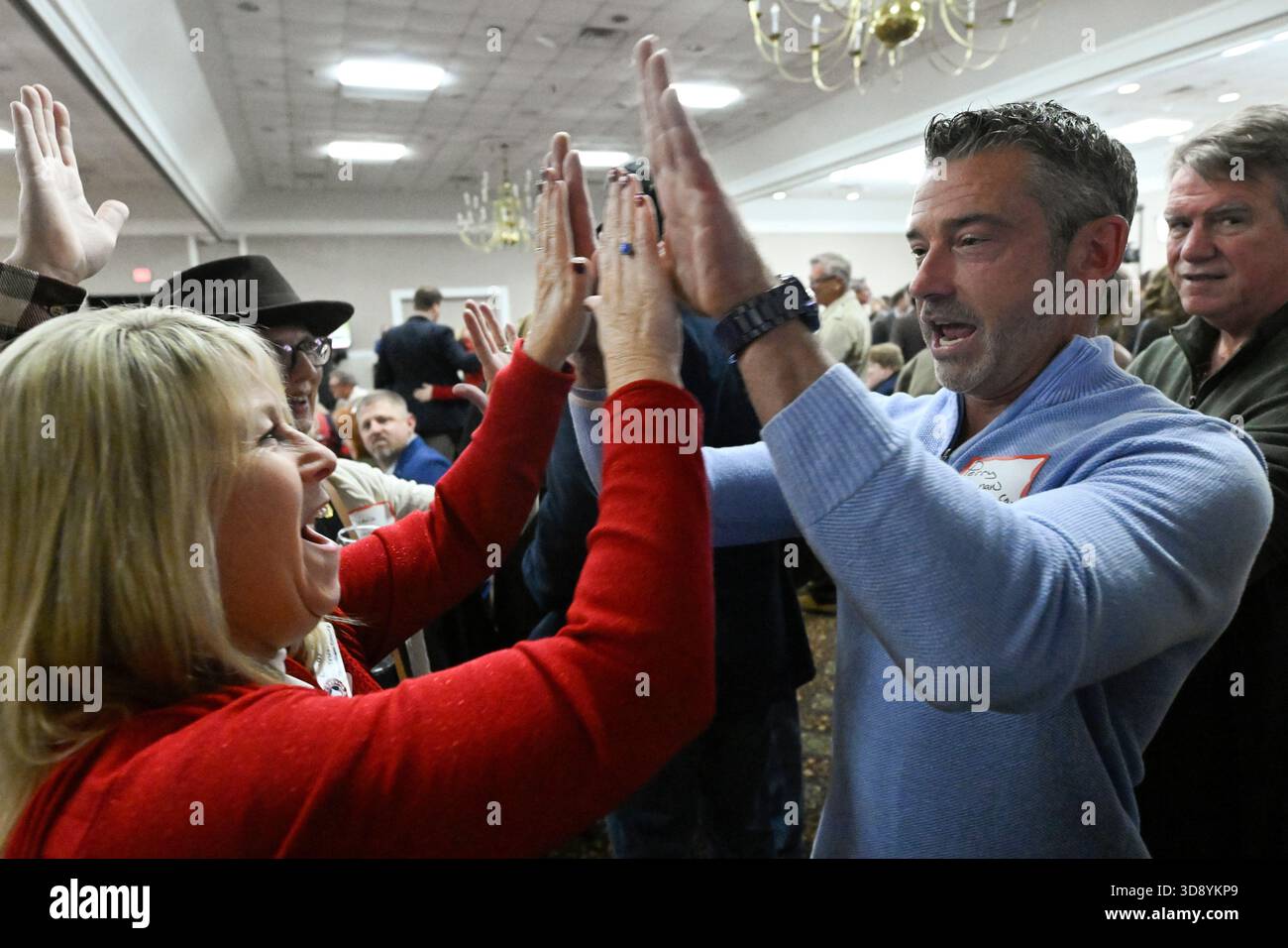 Cindy Perry, left, and Perry Keenan celebrate a county being called ...