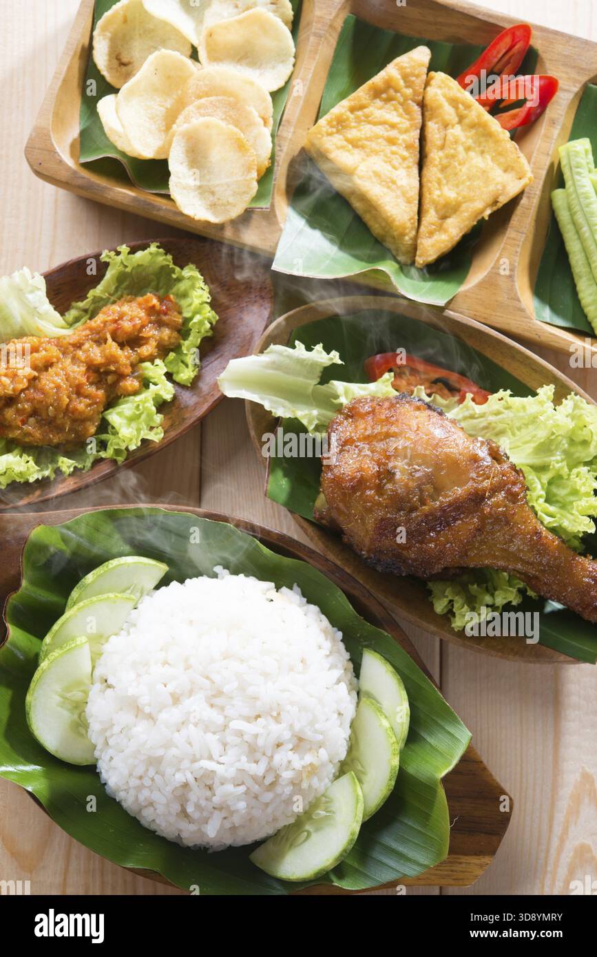 Famous traditional Indonesian food. Delicious nasi ayam penyet with ...