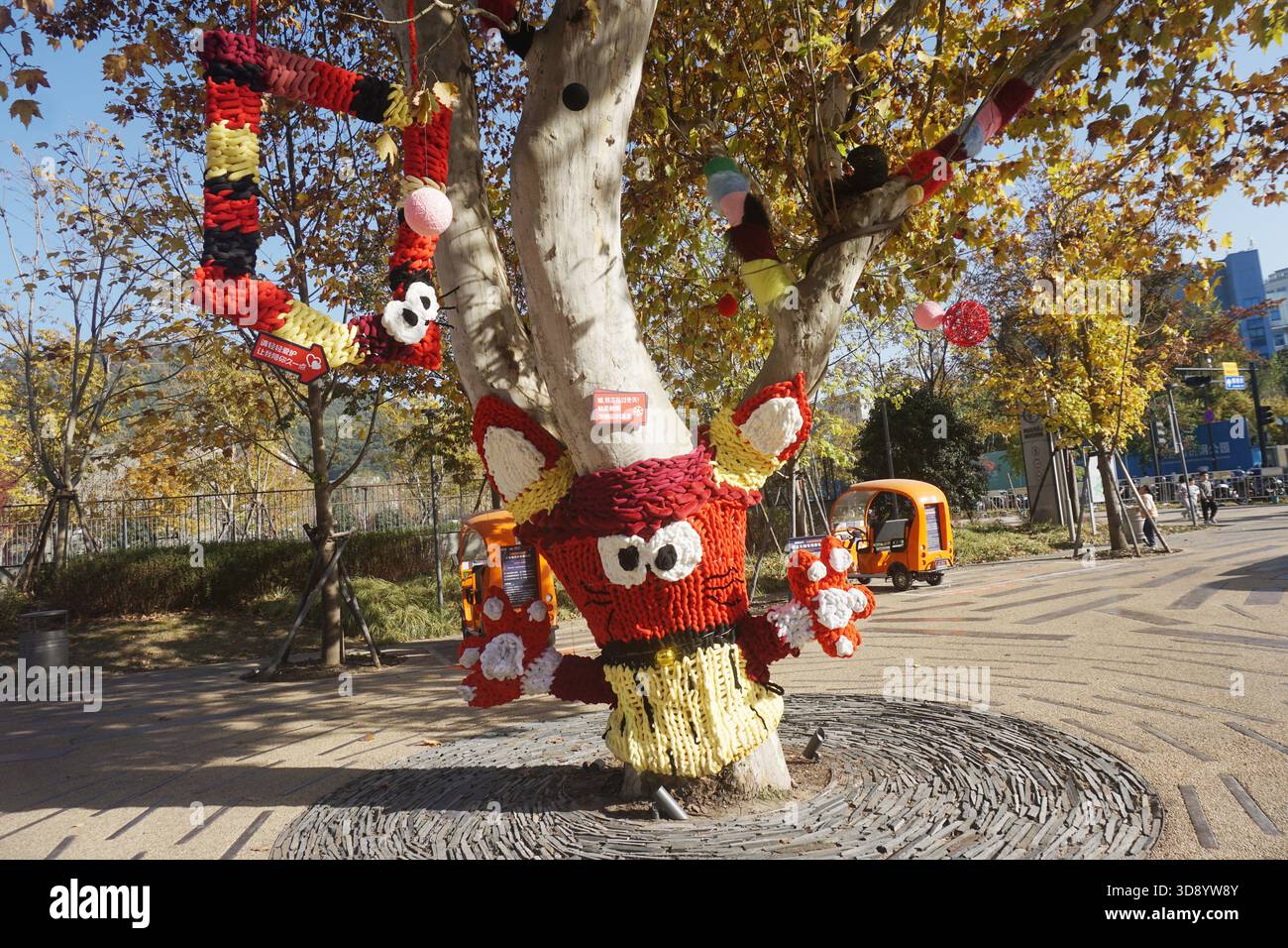 HANGZHOU, CHINA - DECEMBER 3, 2025 - A big tree wearing a cartoon ...