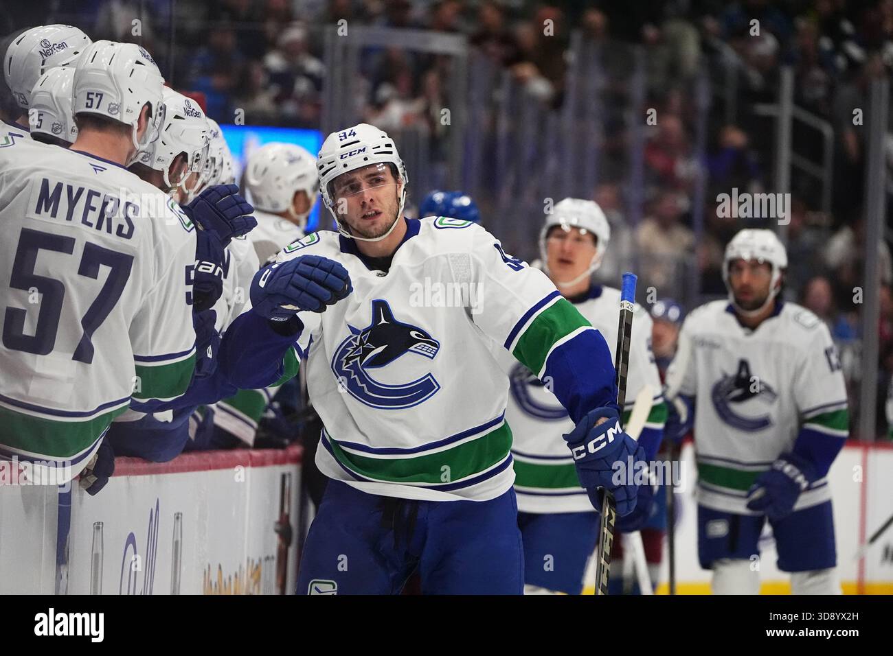 Vancouver Canucks center Linus Karlsson is congratulated as he passes ...