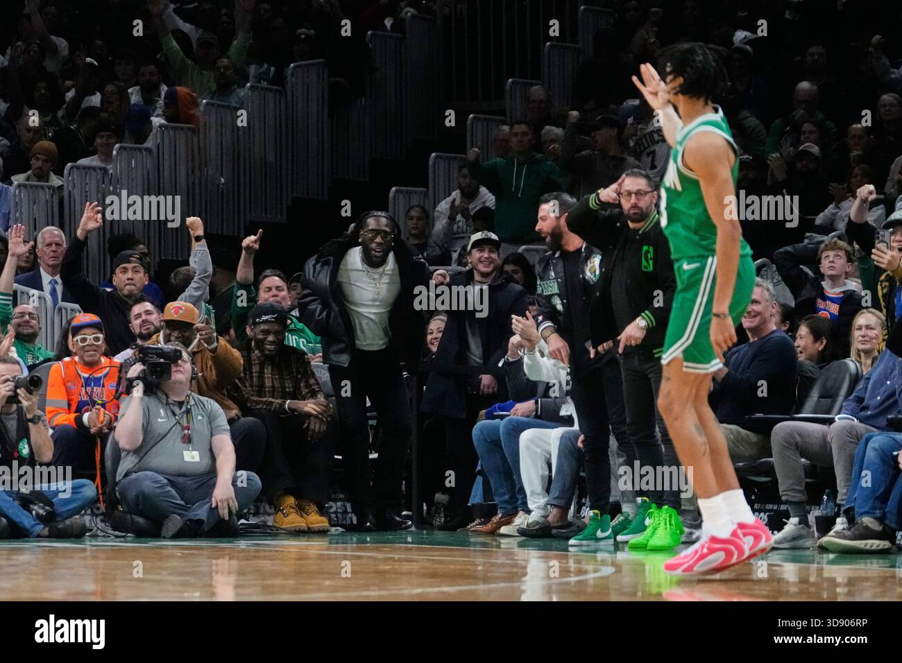 Boston Celtics forward Josh Minott, right, looks down court while ...