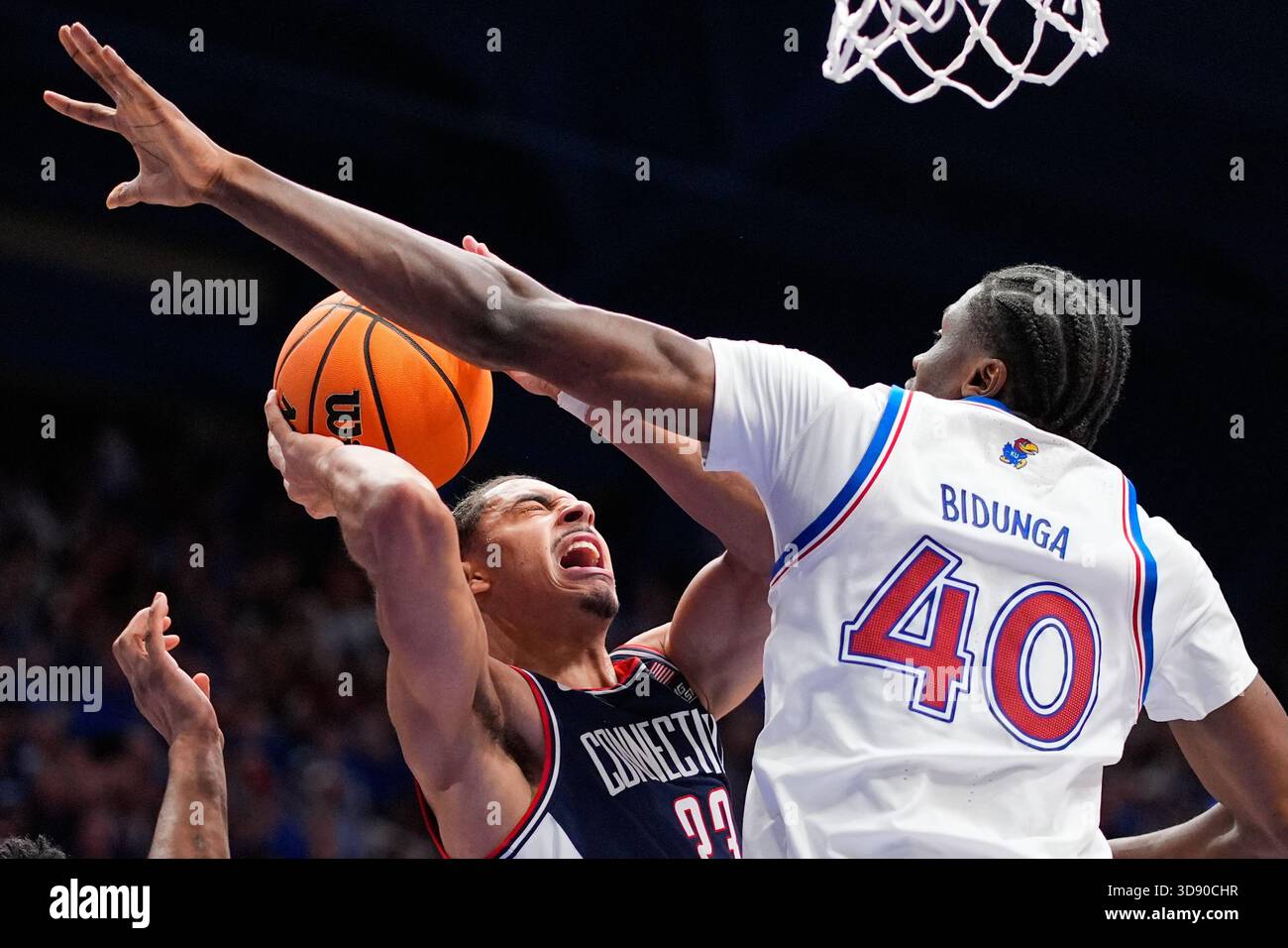 UConn forward Jayden Ross (23) shoots under pressure from Kansas ...