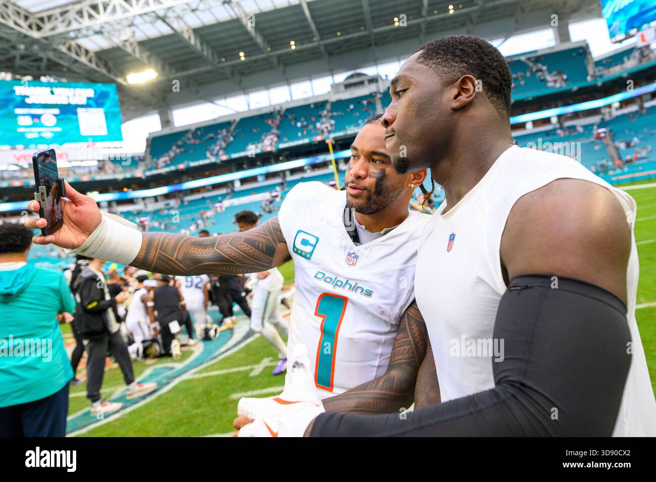 Miami Dolphins quarterback Tua Tagovailoa (1) and linebacker K.J. Britt ...