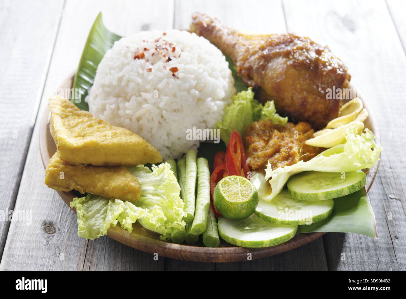Famous traditional Indonesian food. Delicious nasi ayam penyet with ...