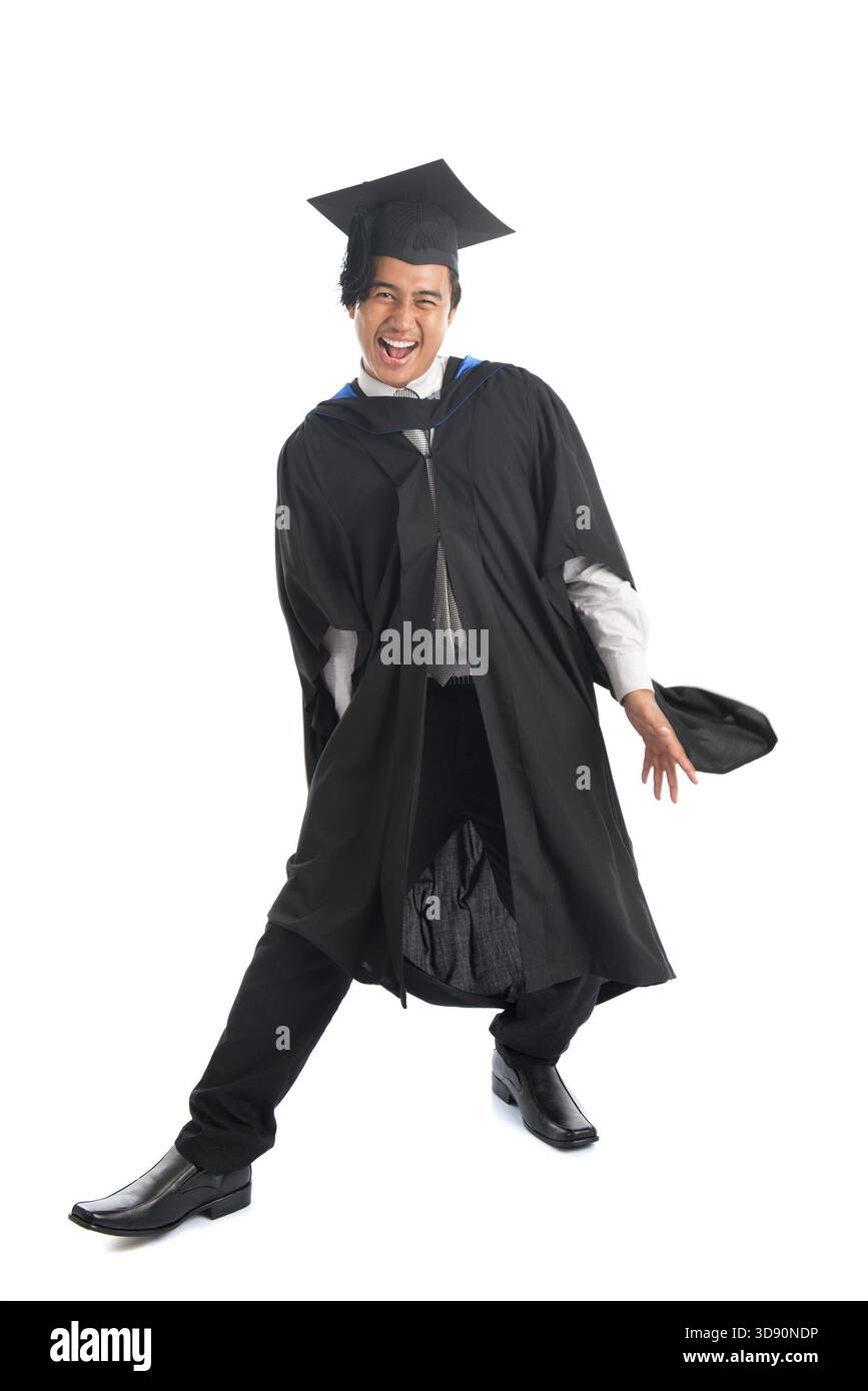 Full body excited Asian male university student in graduation gown ...