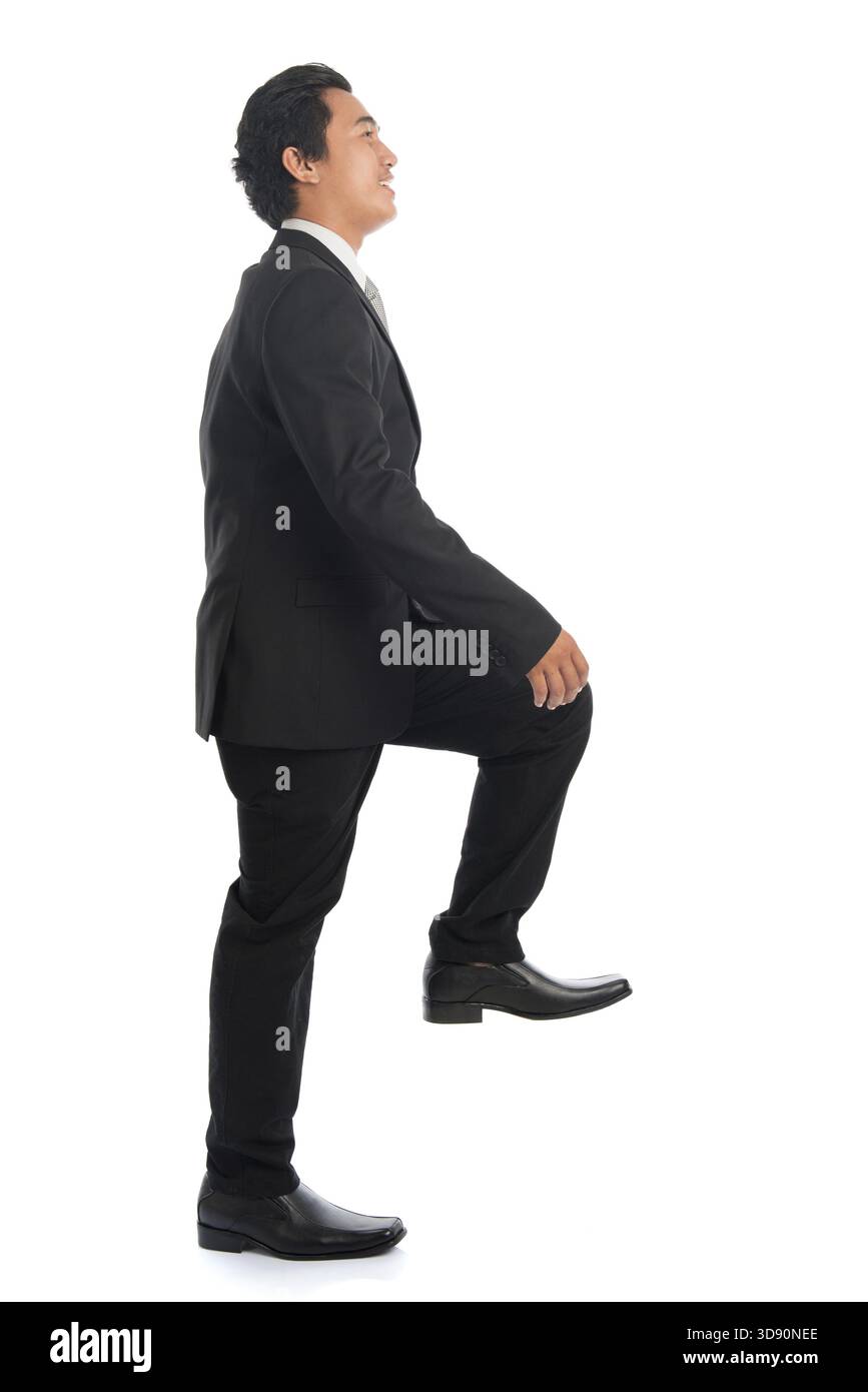 Full body side view of attractive young Southeast Asian businessman ...