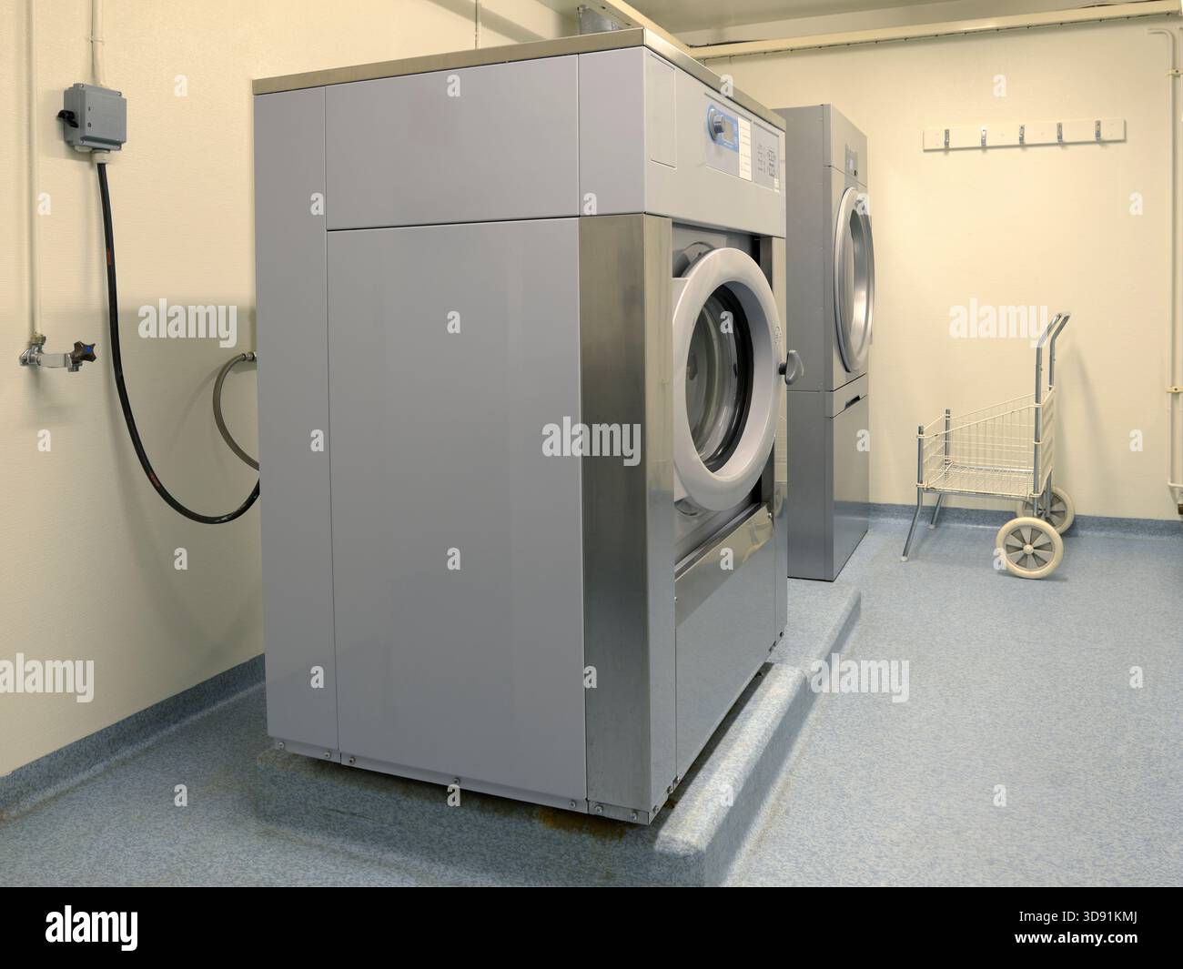 Shared apartment building laundry room with washing machine Stock Photo ...