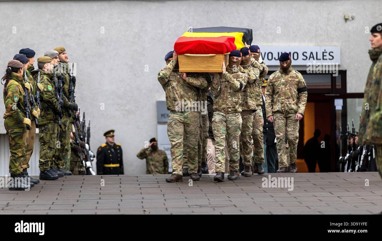 Belgian soldiers carry the flag-draped coffin of a Belgian soldier who ...