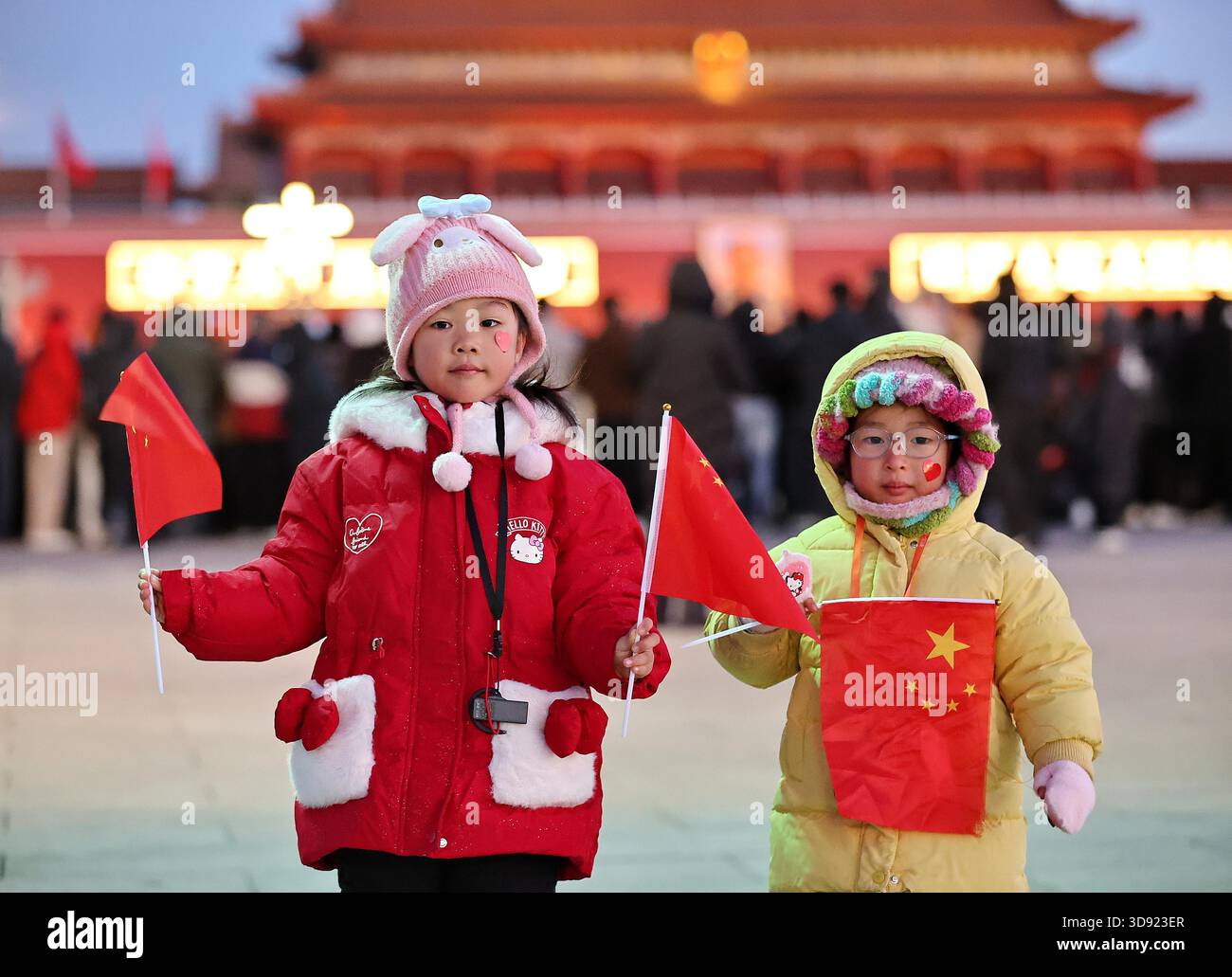 Tourists watch the flag-raising ceremony at Tiananmen Square in Beijing ...