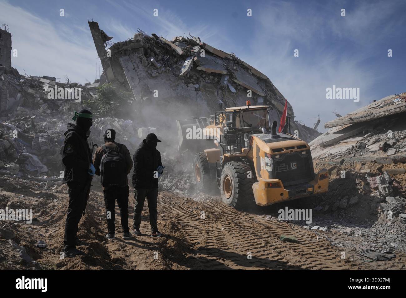 Islamic Jihad and Hamas militants search for the remains of deceased hostages in Beit Lahiya ...