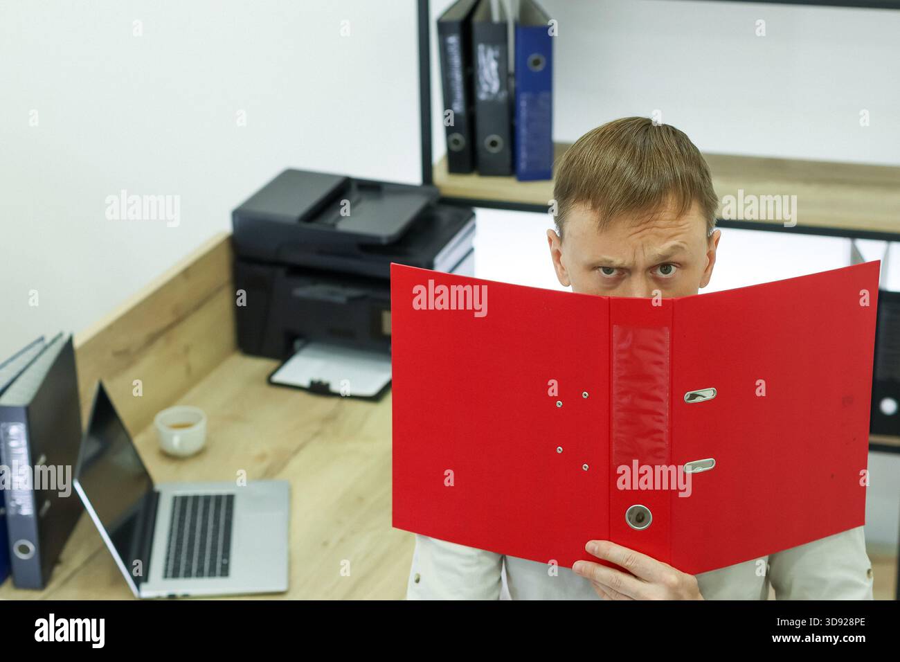 Suspicious employee hiding behind hi-res stock photography and images ...