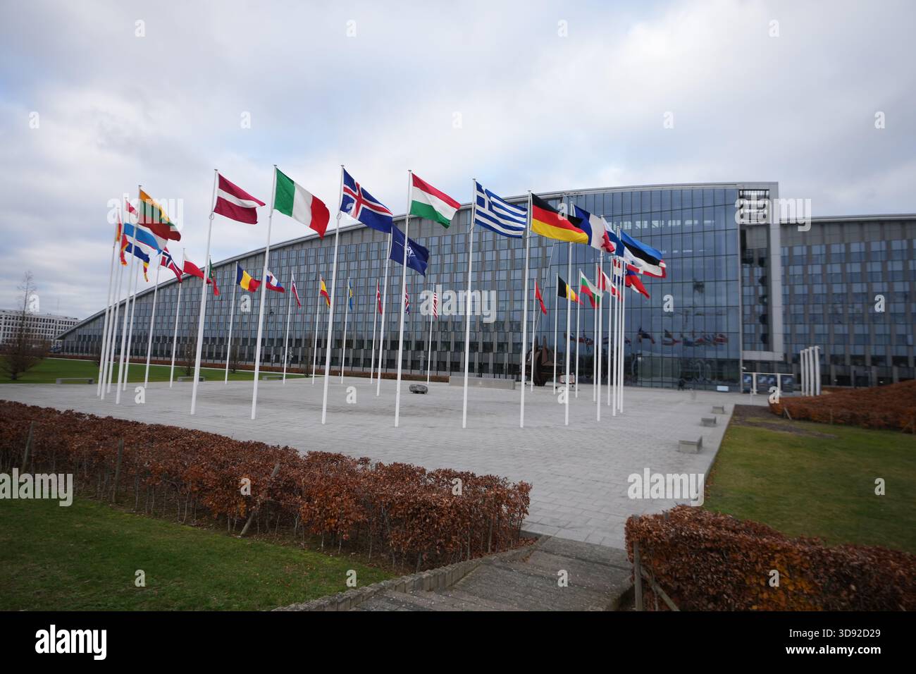 Flags flap in the wind outside of NATO headquarters in Brussels ...